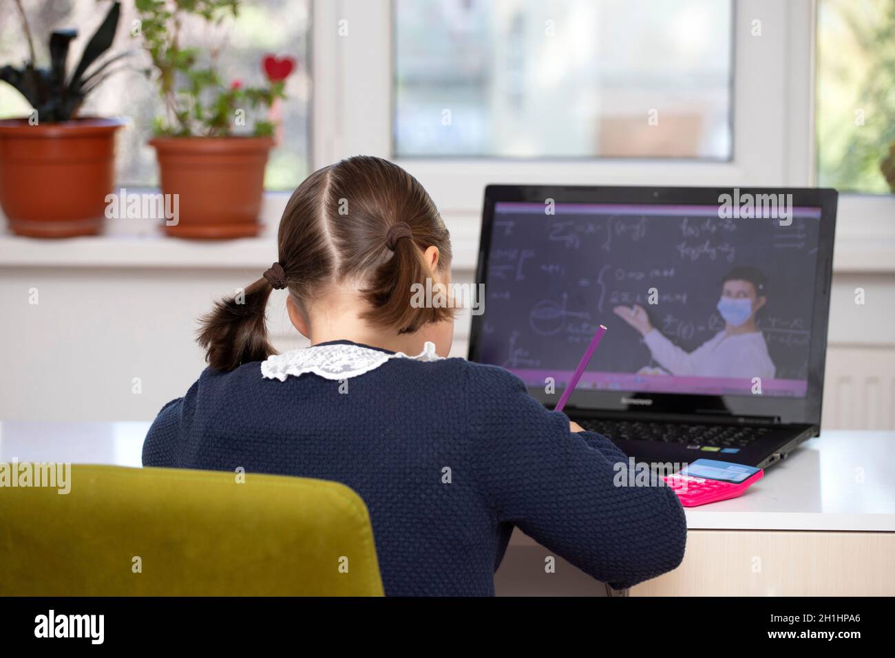 Distance learning-online education. School girl watching online ...