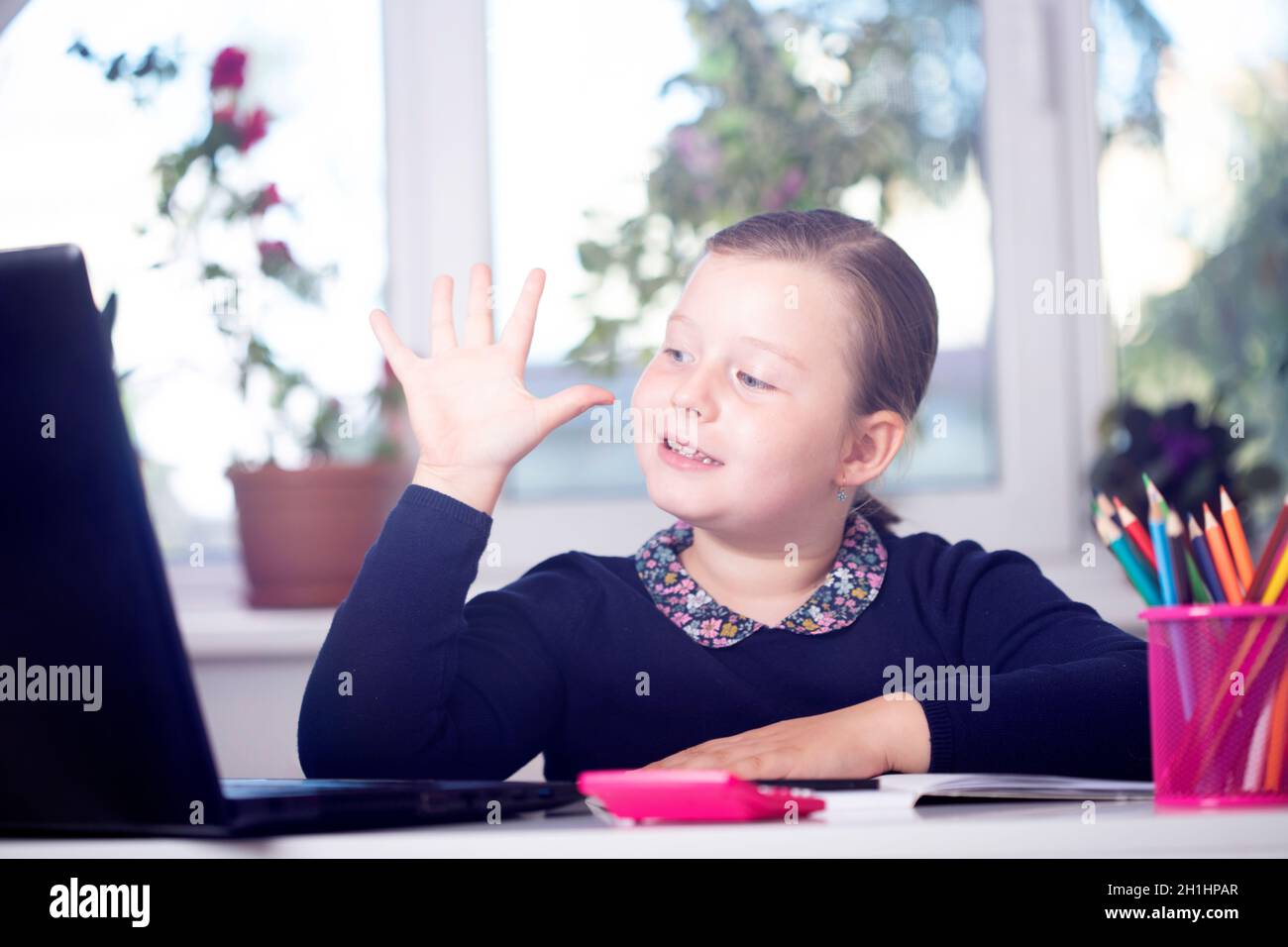 Distance learning-online education. School girl watching online ...