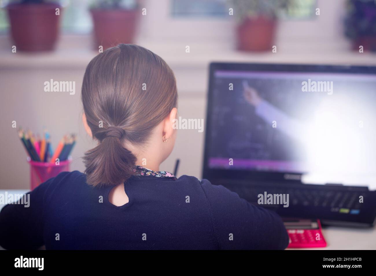 Distance learning-online education. School girl watching online ...