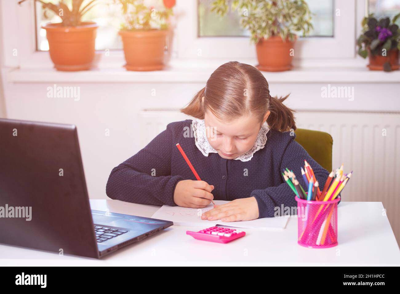 Distance learning-online education. School girl watching online ...