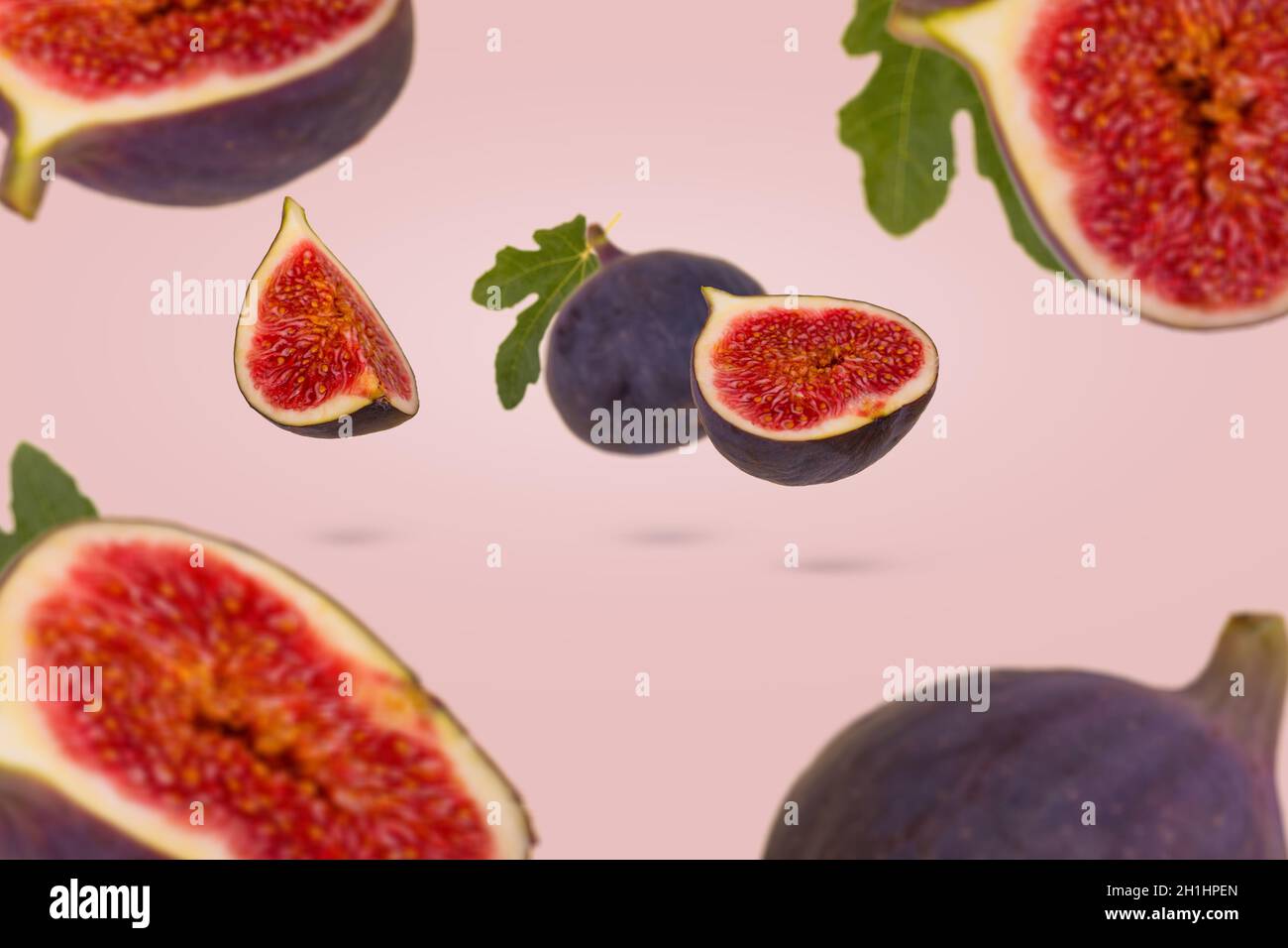 Creative layout of Fresh ripe whole and sliced figs flying in air ...