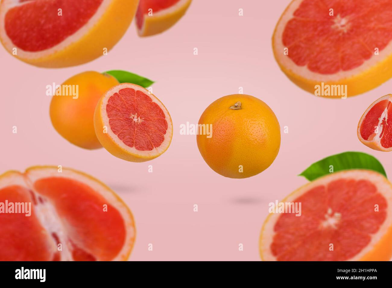 Creative idea with fresh grapefruit sliced on pastel pink background ...