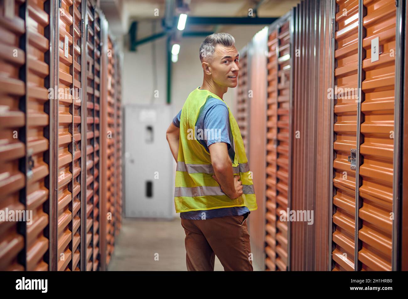 Man in special vest turned back Stock Photo - Alamy