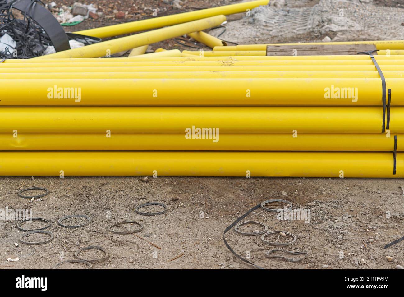 New yellow pipes material at construction site Stock Photo - Alamy