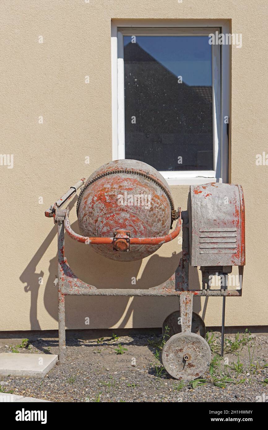 Gas powered concrete cement mixer near new house Stock Photo - Alamy