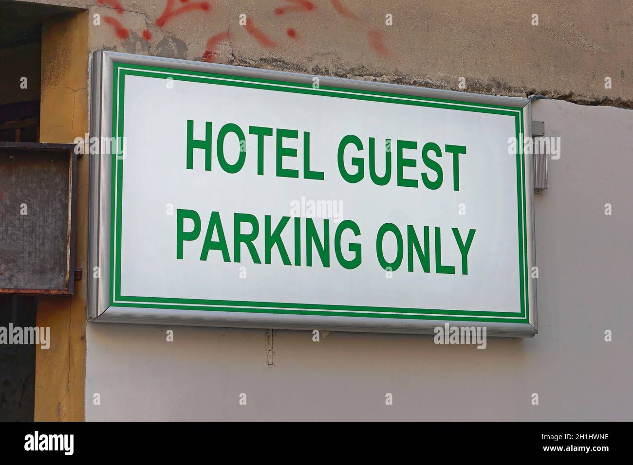 Hotel guest parking only reserved sign board at wall Stock Photo - Alamy