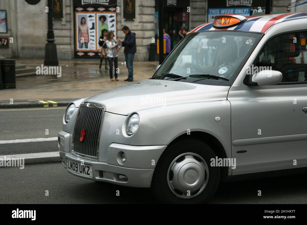 London, UK - August 12, 2010: Taxi in the street of London. Cabs are ...