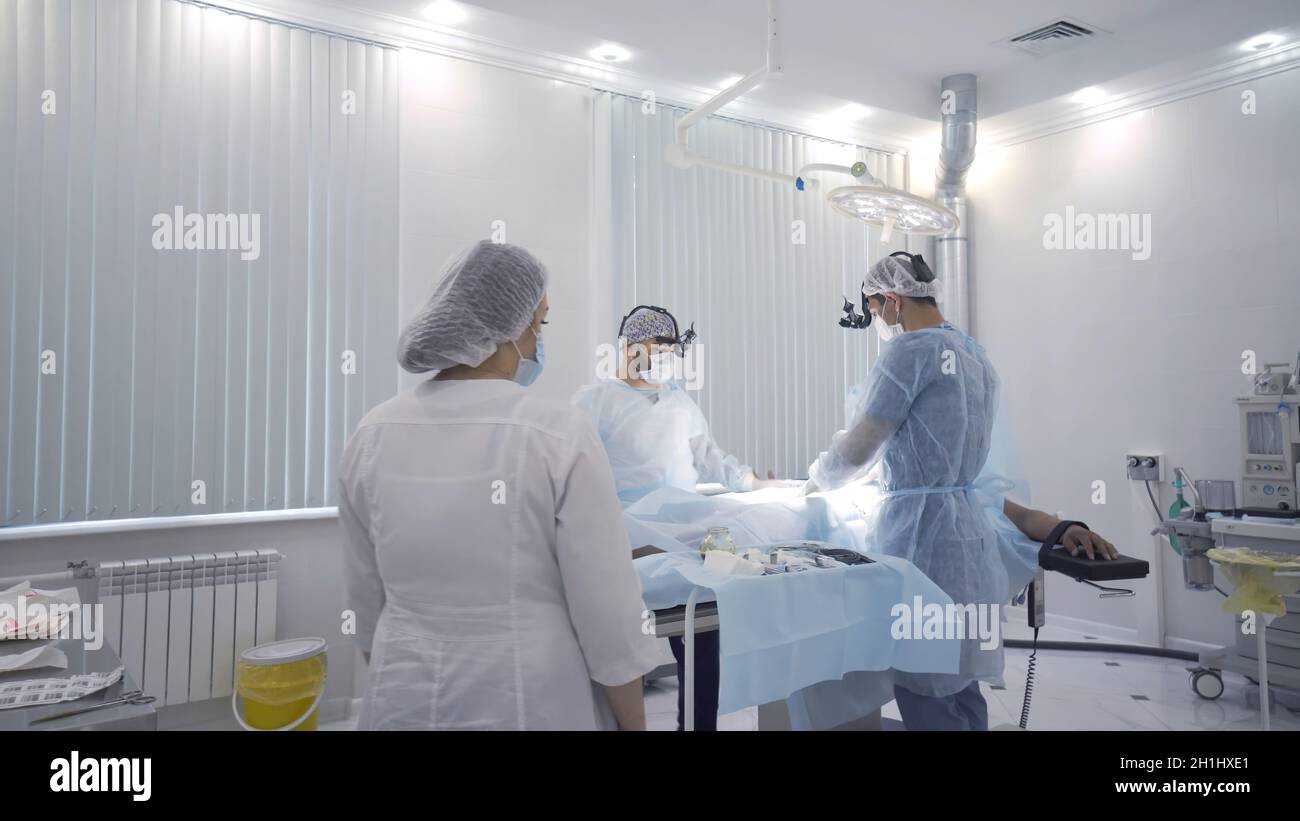 Professional doctors and nurse prepare patient for surgery. Action ...
