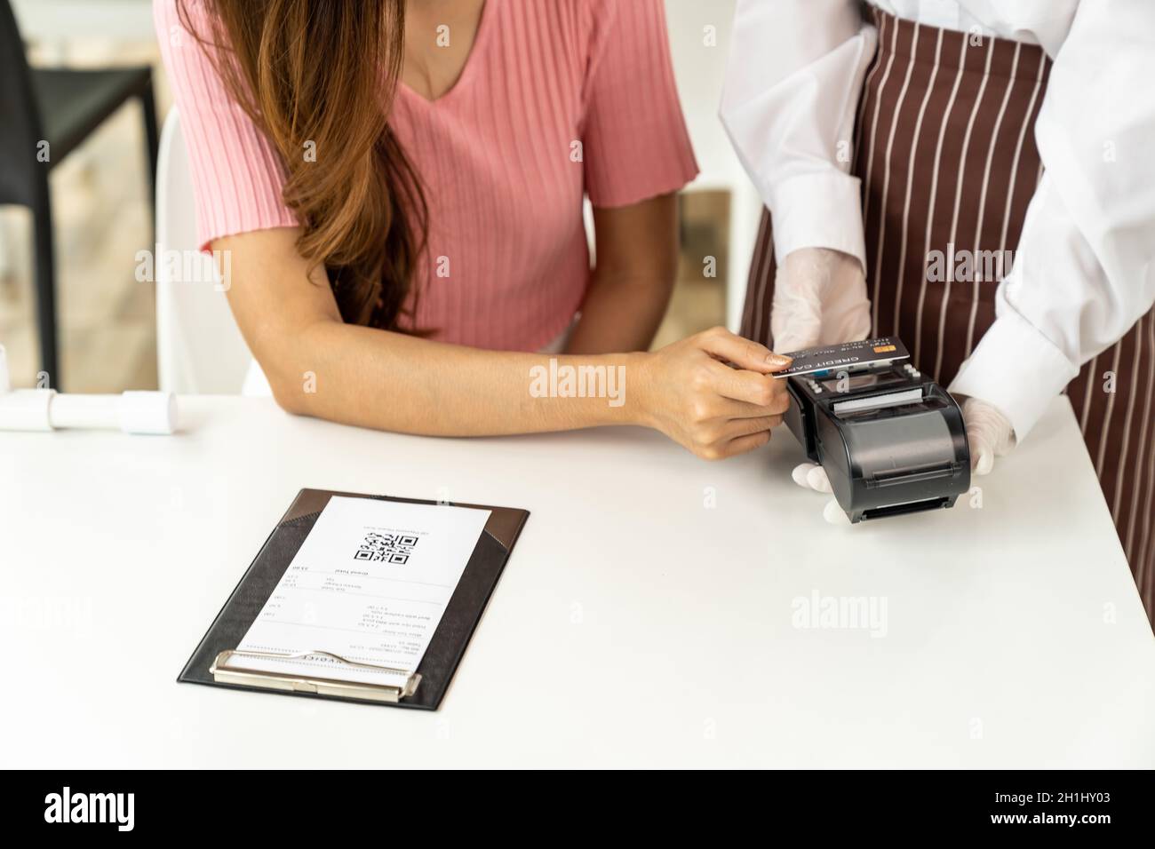 Close up Asian woman customer make contactless credit card payment ...