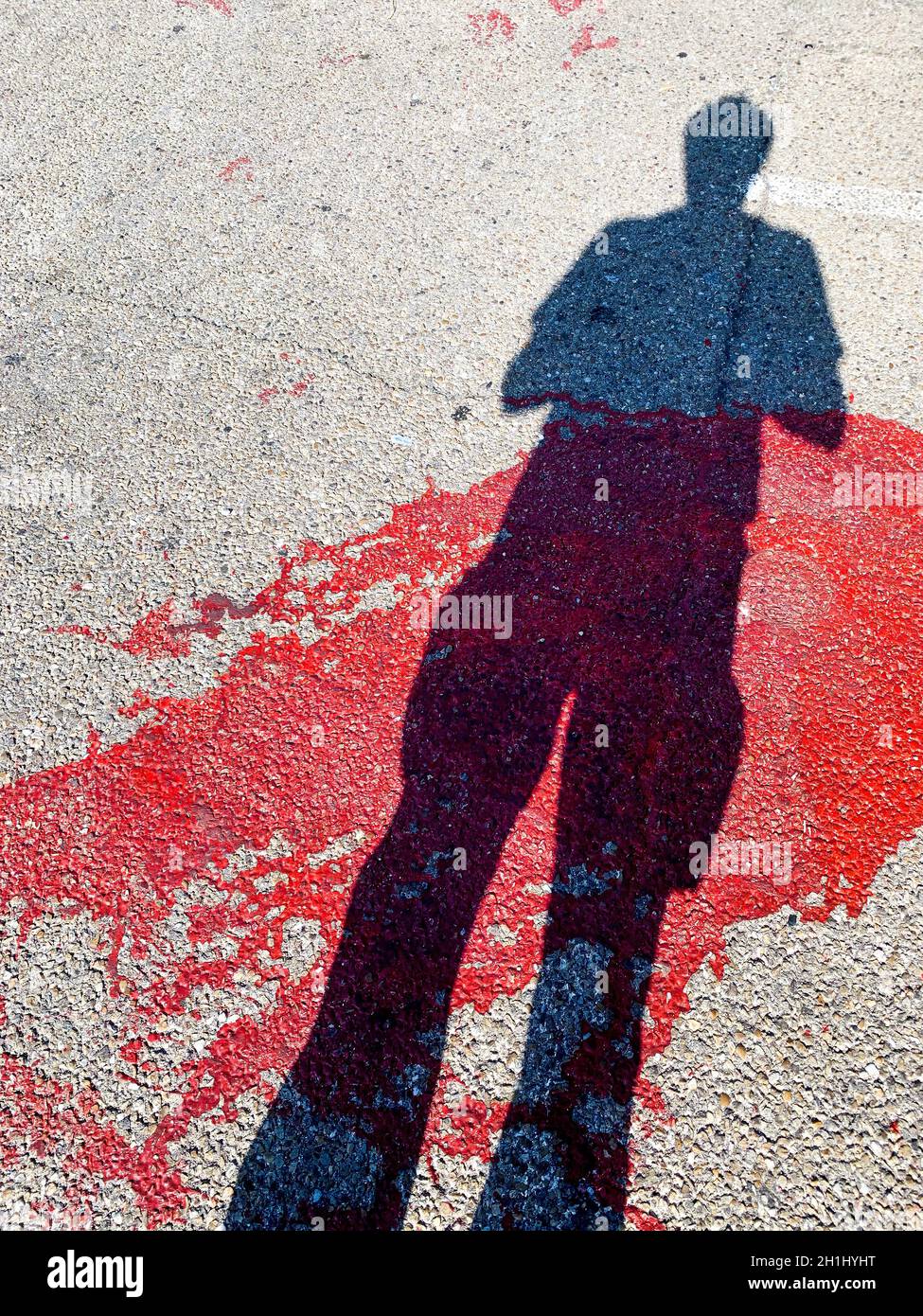 Human shadow projected on a red paint stain, France Stock Photo - Alamy