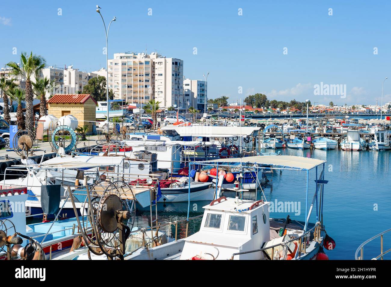 Marina with yachts and cityscape of Larnaca with waterfront apartments ...