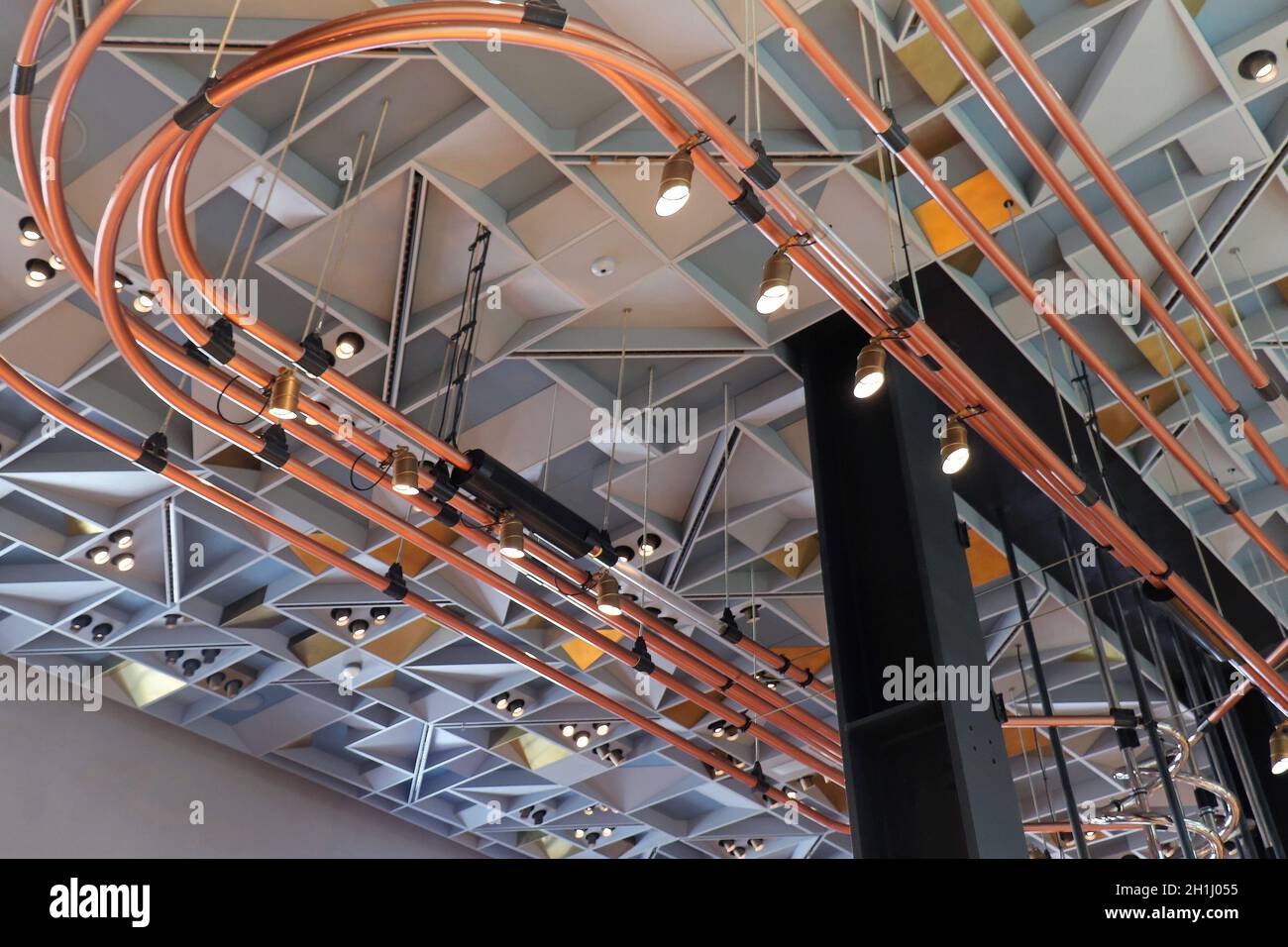 Colorful metal installation pipes on interior ceiling Stock Photo - Alamy