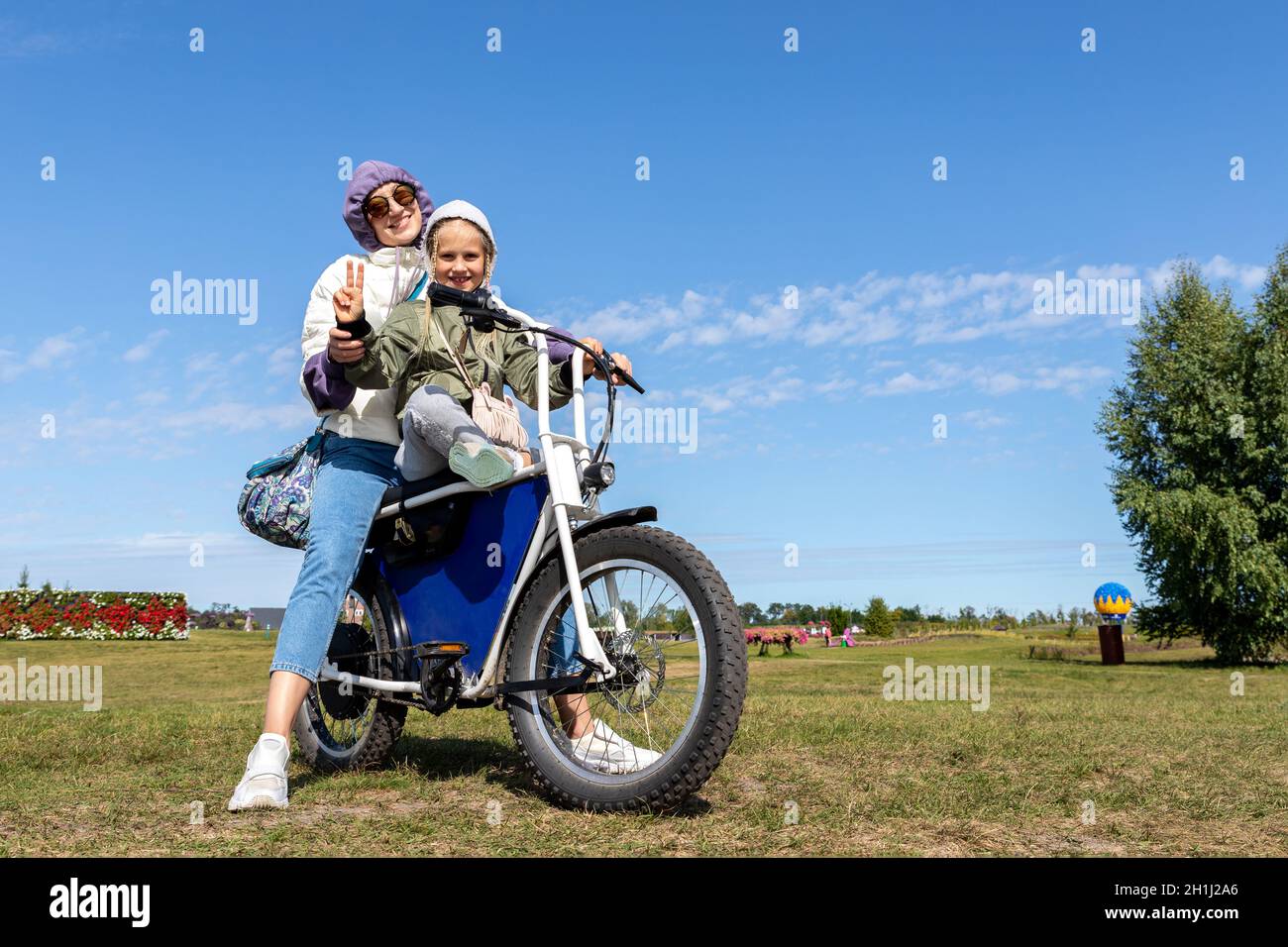 Young adult beautiful mother and daughter enjoy having fun riding ...