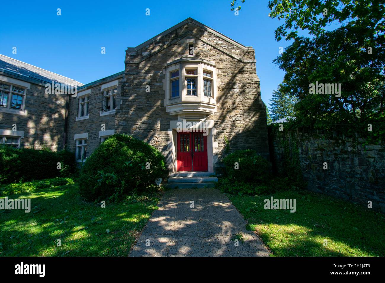 A Cobblestone Church With a Path Leading Up to a Red Door On a Clear ...