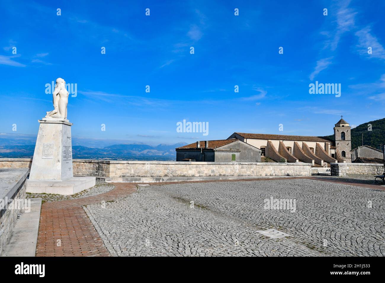 A monument to women in a square of a medieval town in the province of ...