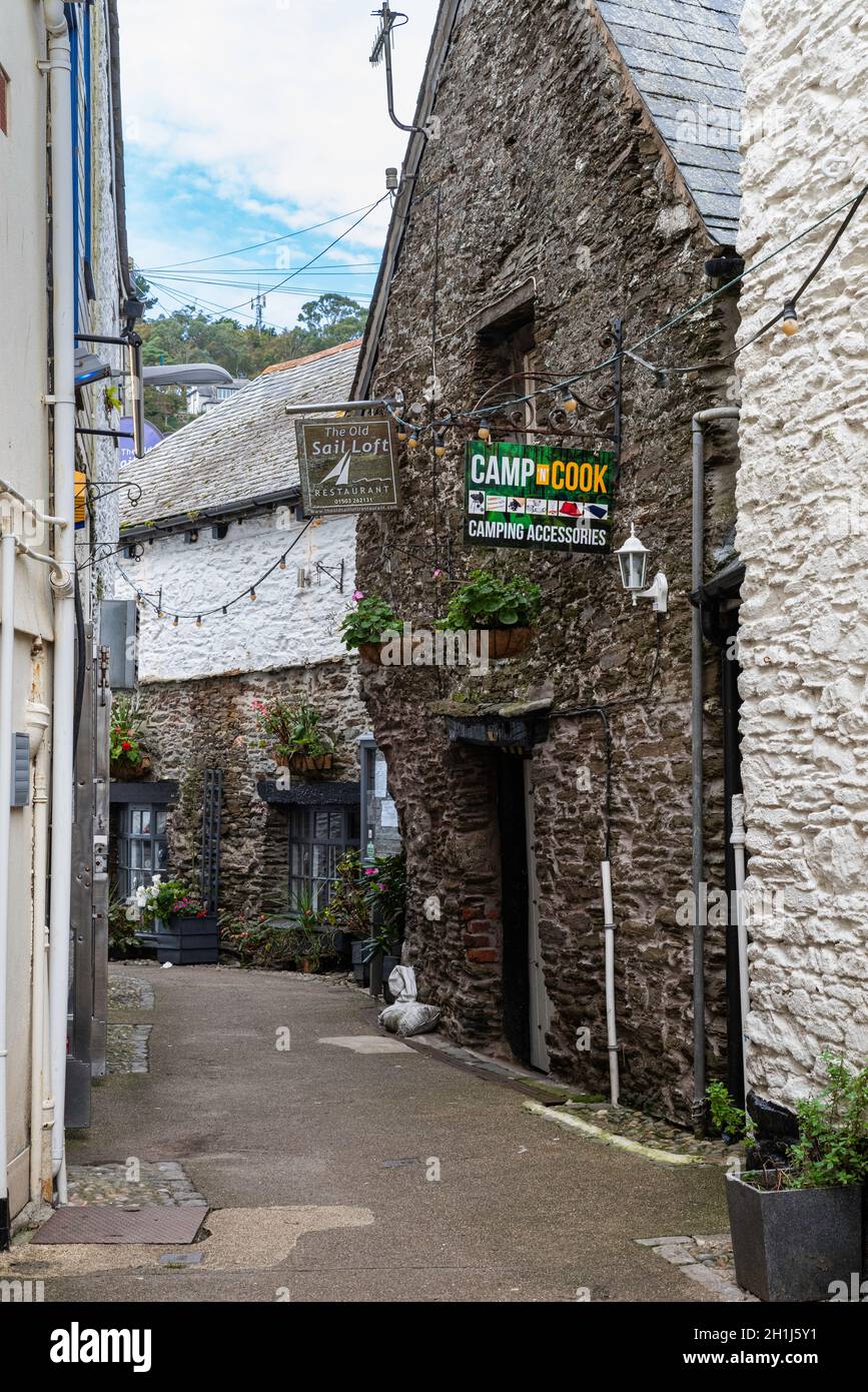 A quiet narrow street with ancient stone buildings in Looe, Cornwall. A ...
