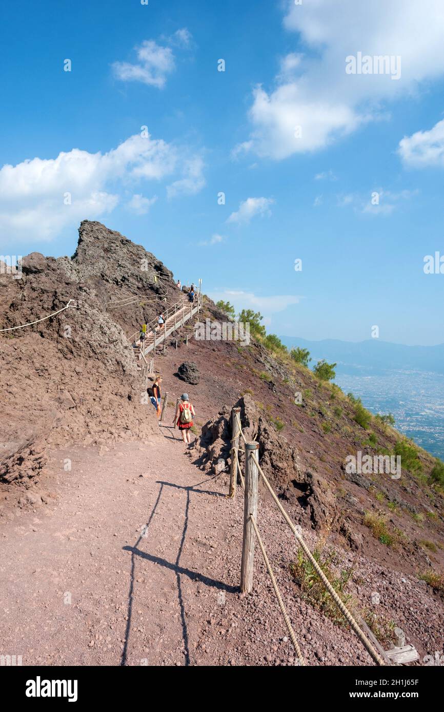 MOUNT VESUVIUS, ITALY - AUGUST 1, 2018: Tourists walk around the crater ...