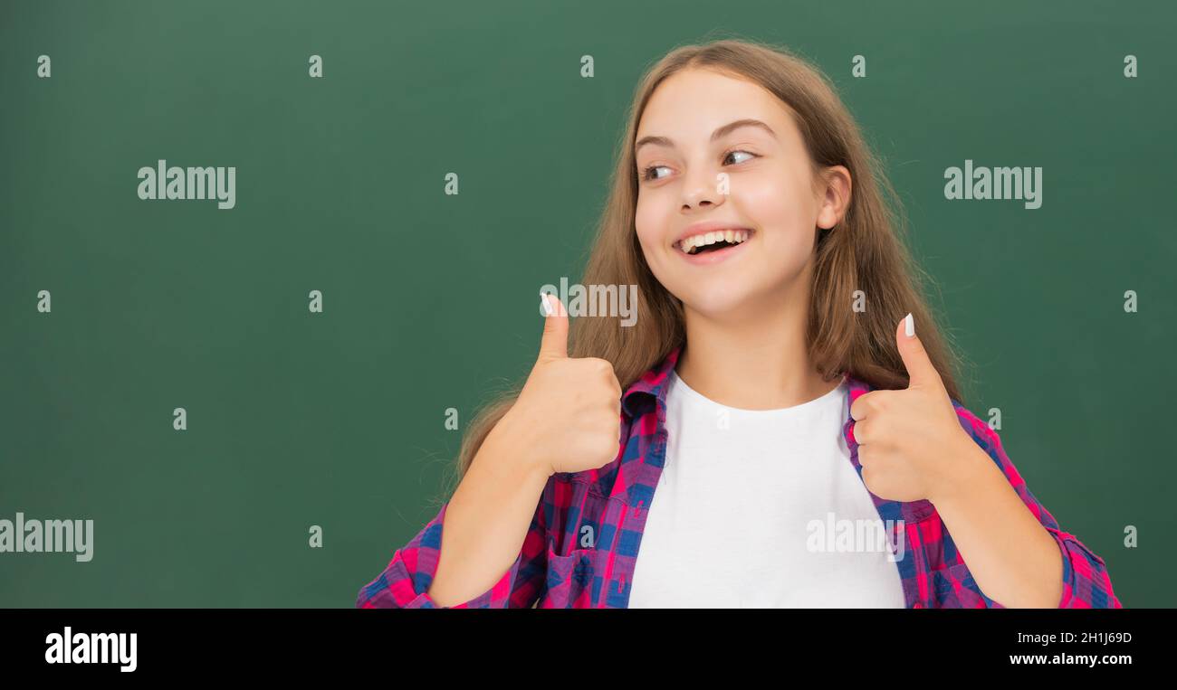 happy teen girl showing thumb up at blackboard, emotions Stock Photo ...