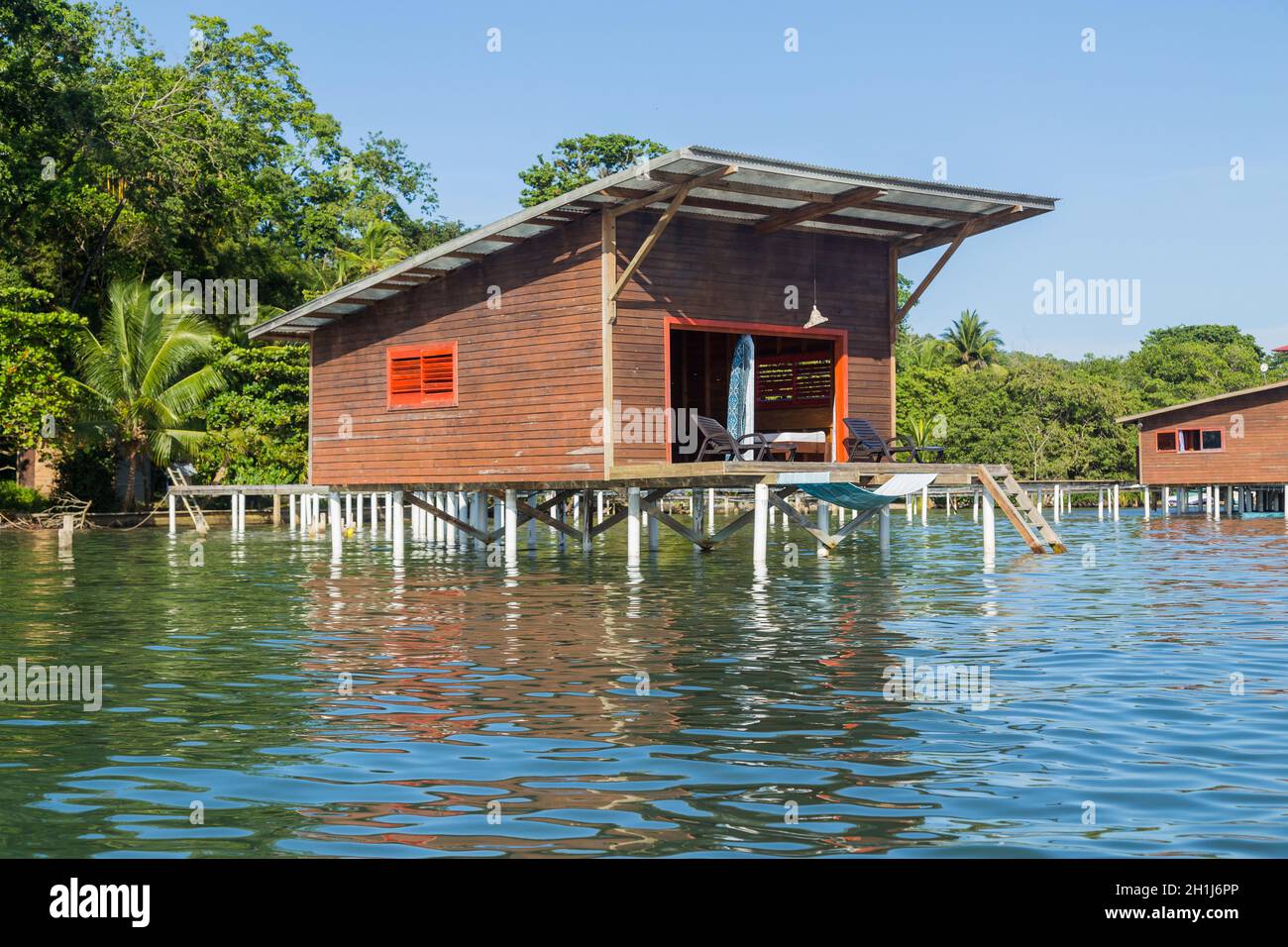 Wood Caribbean buildings over the water with boats at dock, Bocas del ...
