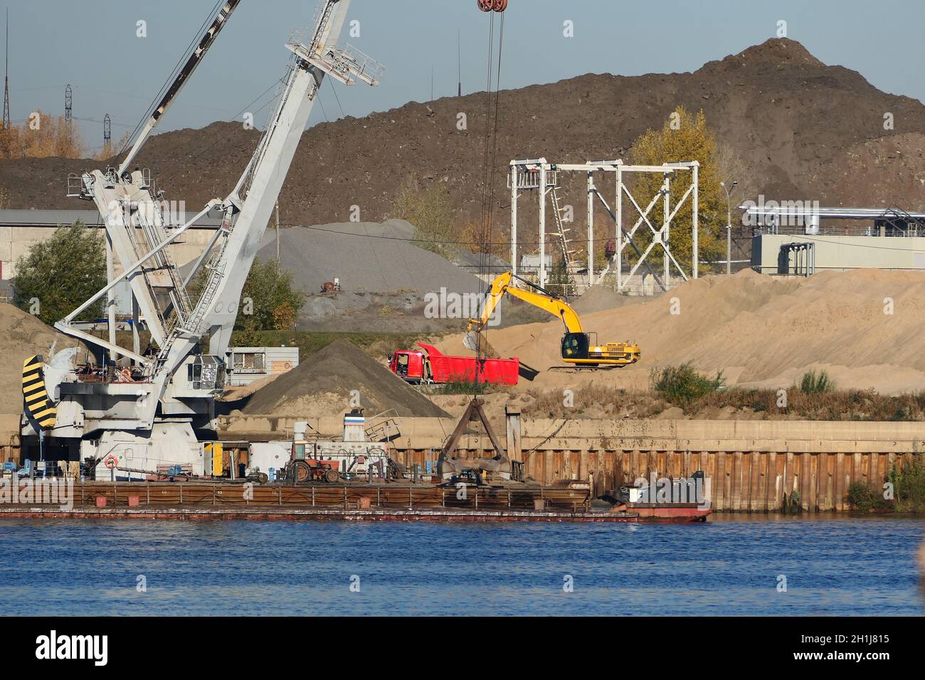 Construction site on the river bank. Extraction and transportation of ...