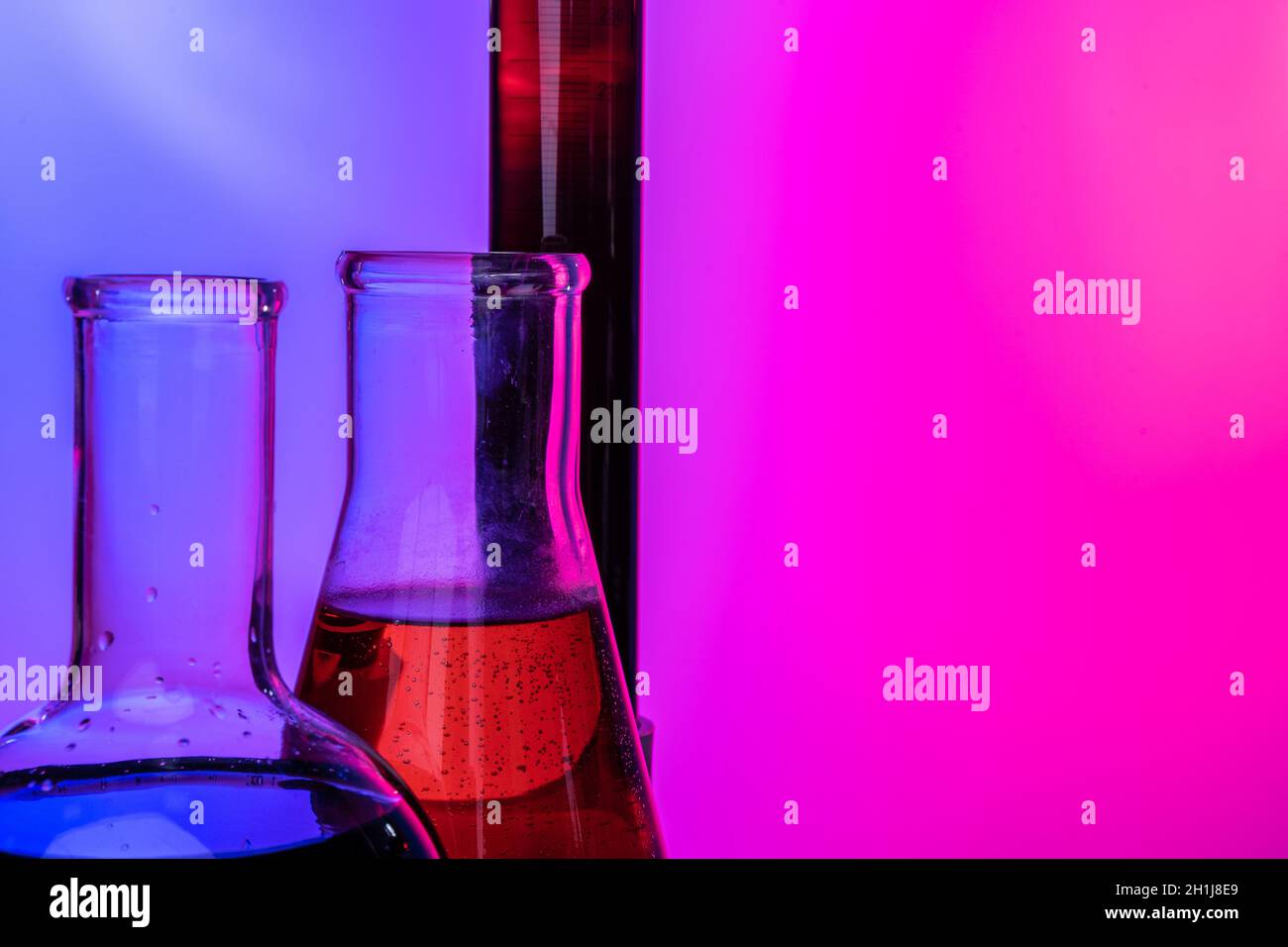 Laboratory glass tubes with chemicals on bright pink background Stock ...