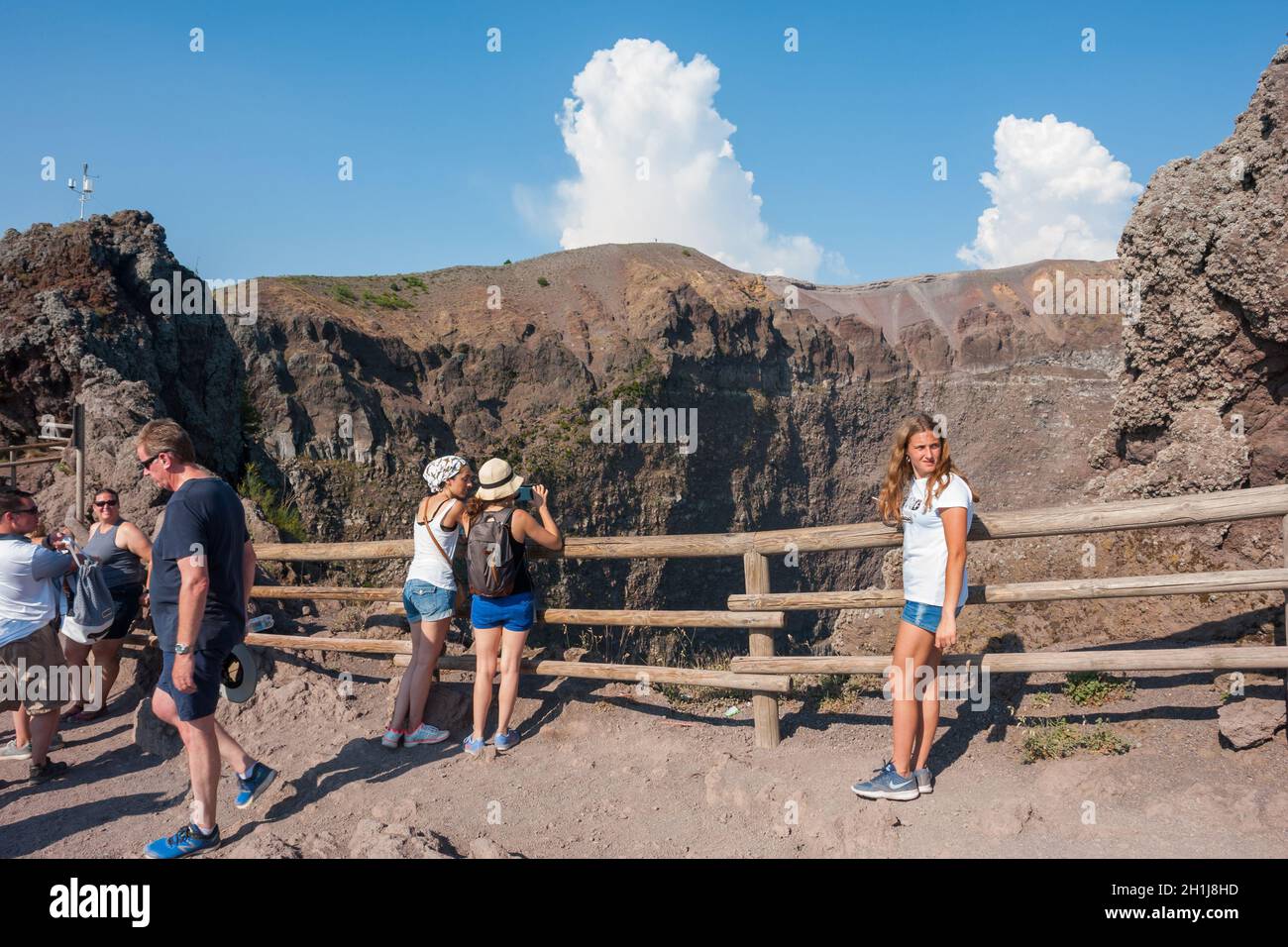 MOUNT VESUVIUS, ITALY - AUGUST 1, 2018: Tourists walk around the crater ...