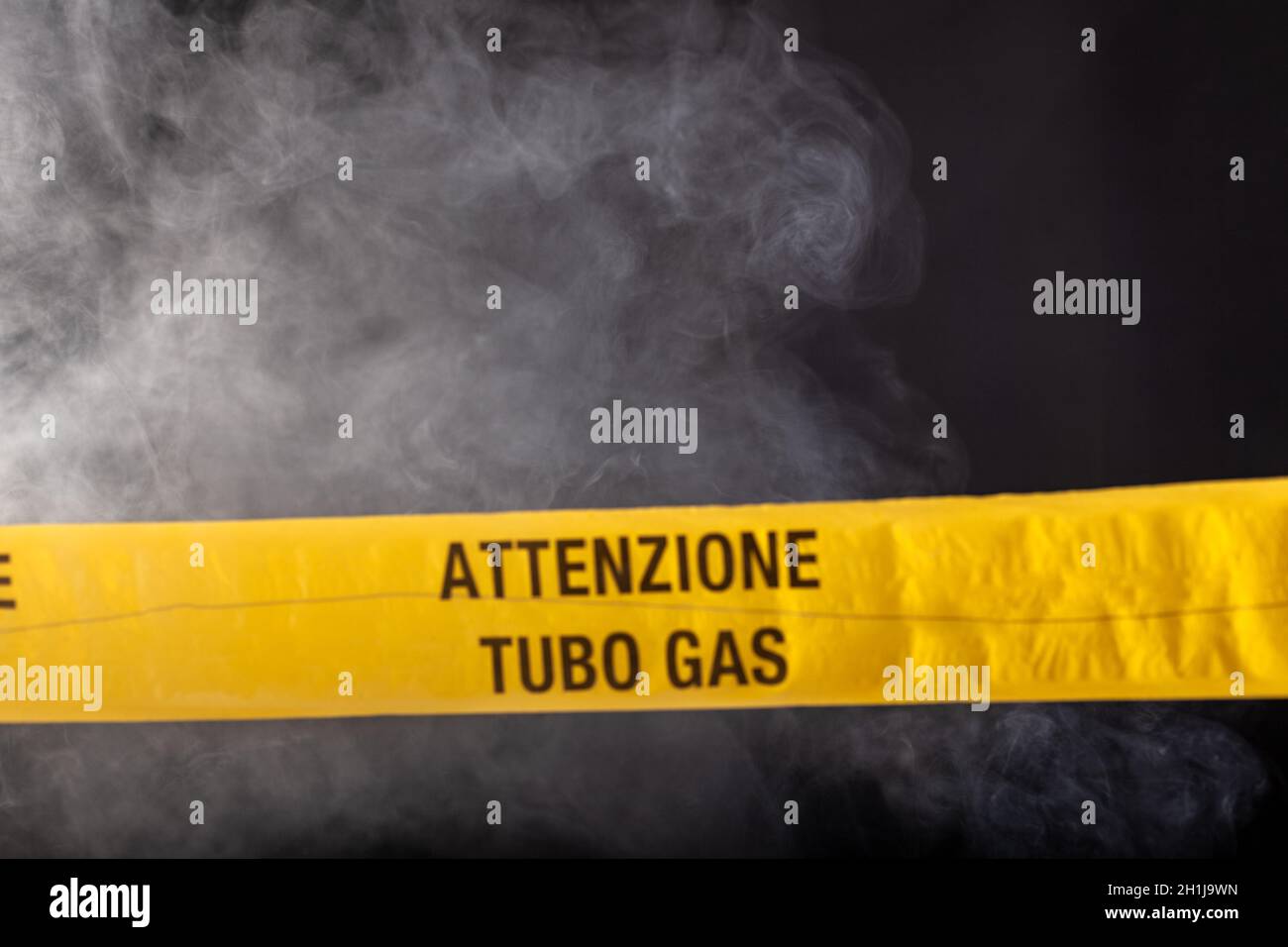 Yellow emergency sign of attention gas pipe on smoke-filled background ...