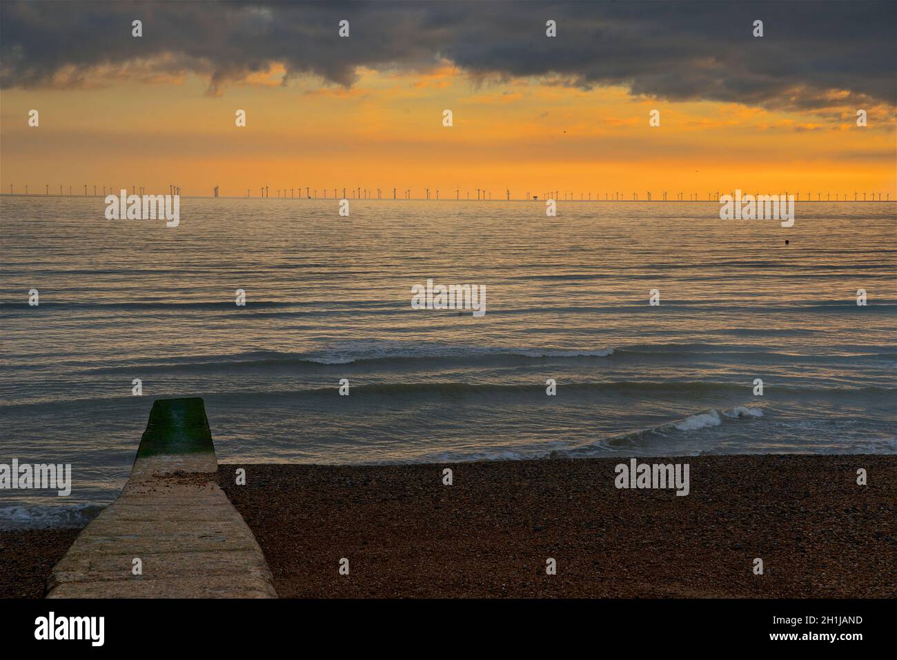 Concrete groyne sea defence and the sea with the Rampion offshore ...