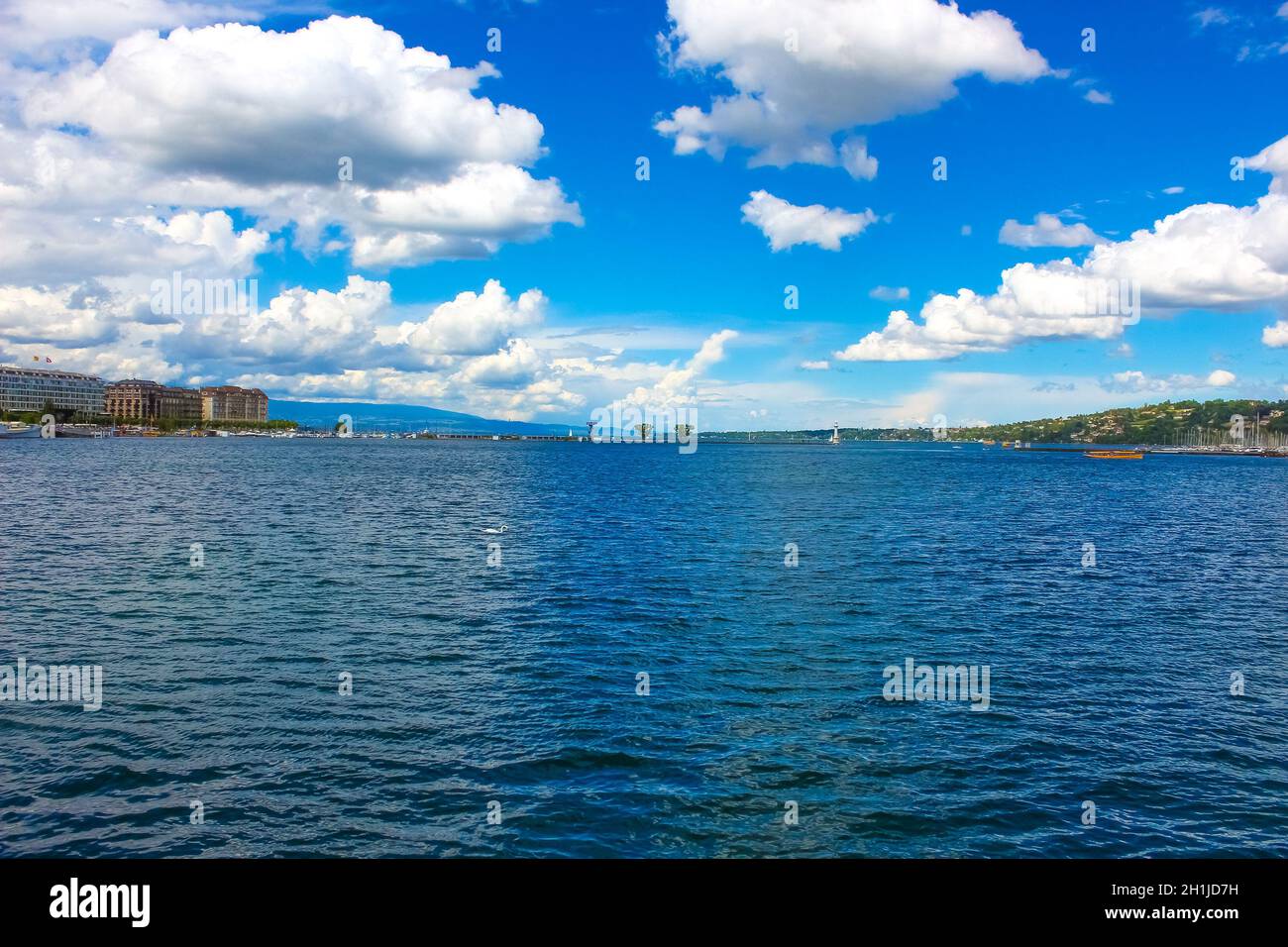 Lake Geneva. Panoramic view of harbor district with blue sky and clouds ...