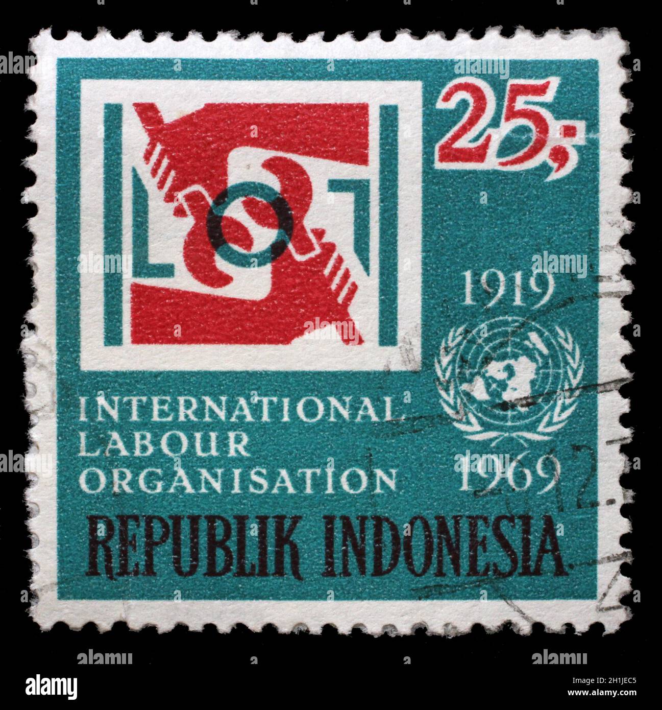 Stamp printed in Indonesia, shows emblem of International Labour ... Stamp printed in Indonesia, shows emblem of International Labour ...