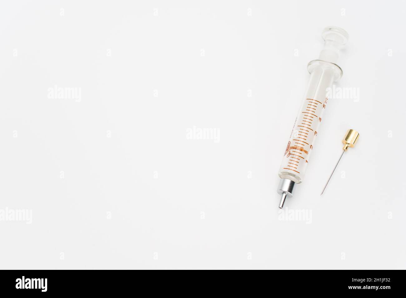 isolated sterilized glass injection syringe on a white surface Stock ...