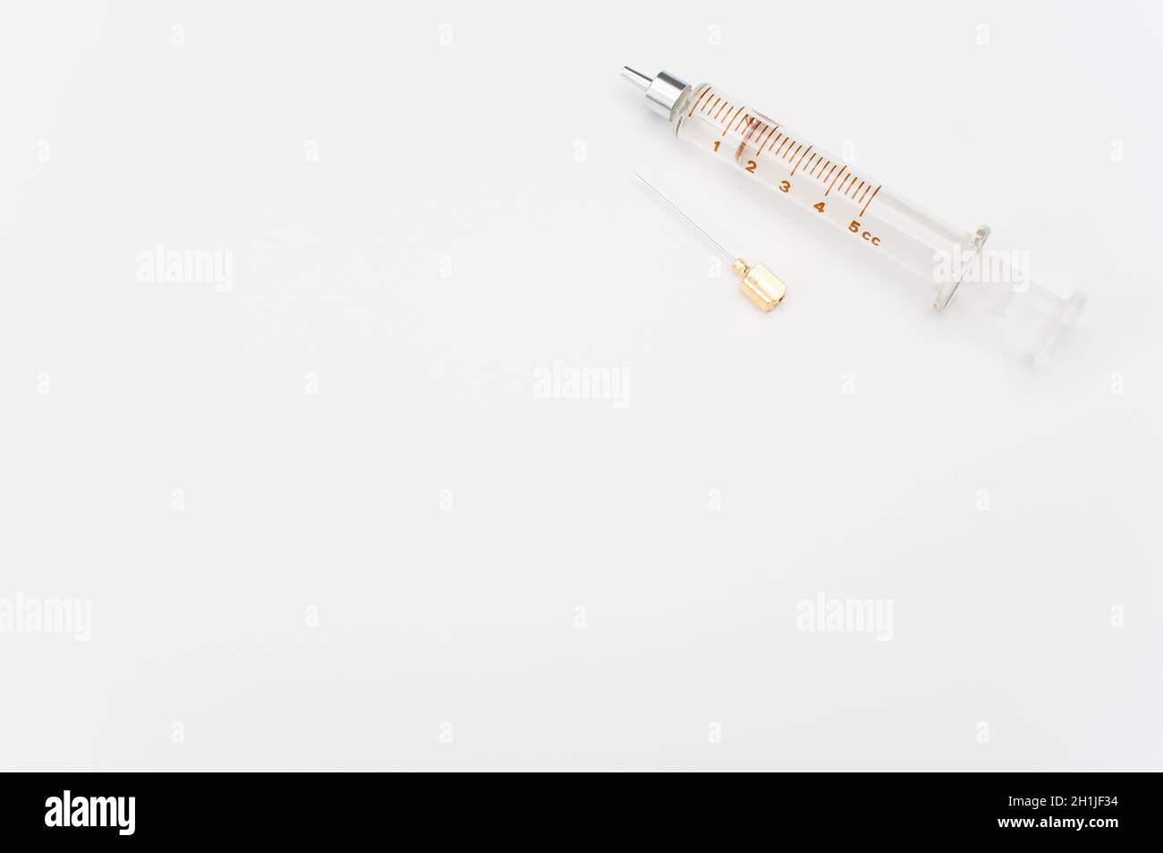 isolated sterilized glass injection syringe on a white surface Stock ...