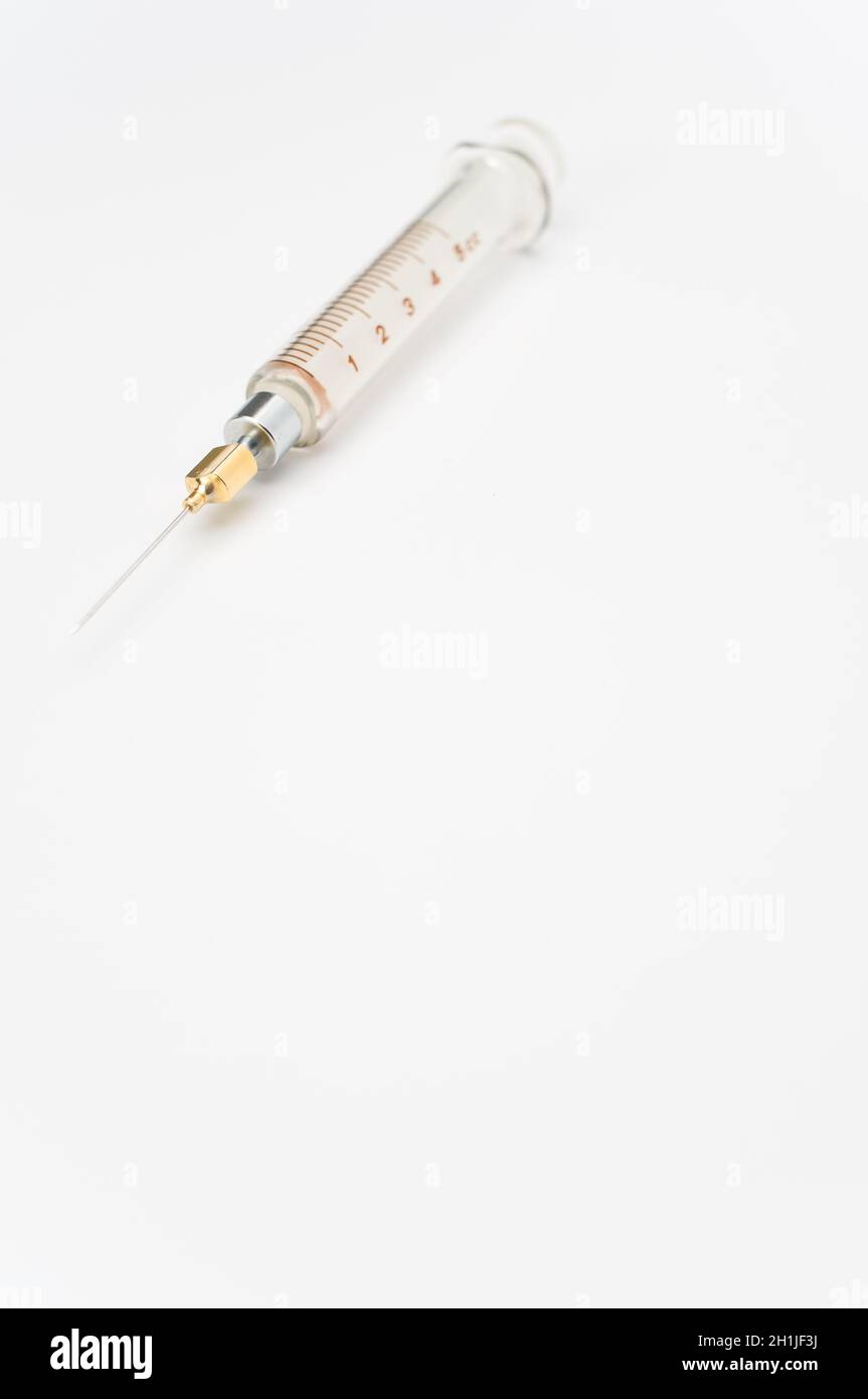 isolated sterilized glass injection syringe on a white surface Stock ...