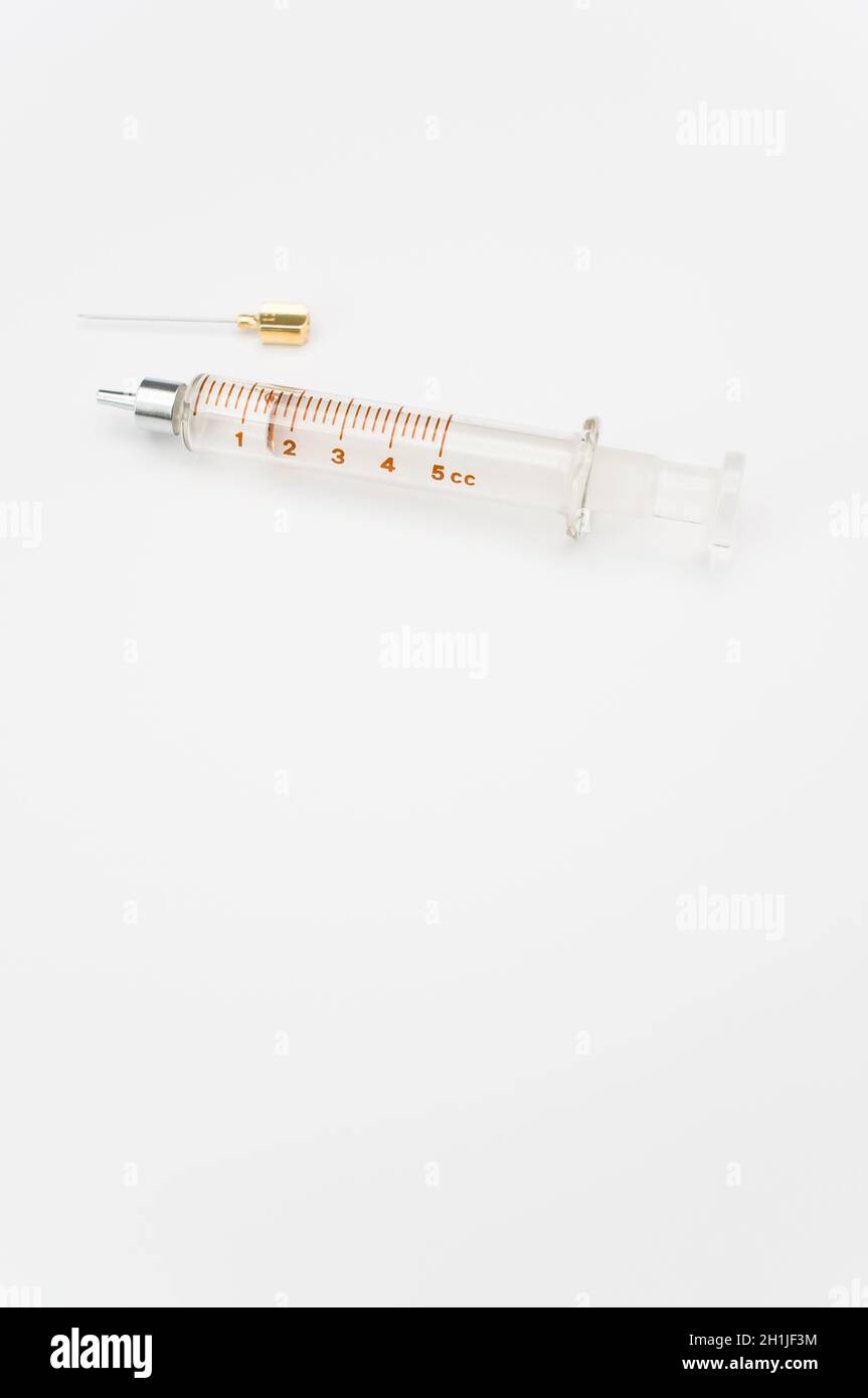 isolated sterilized glass injection syringe on a white surface Stock ...