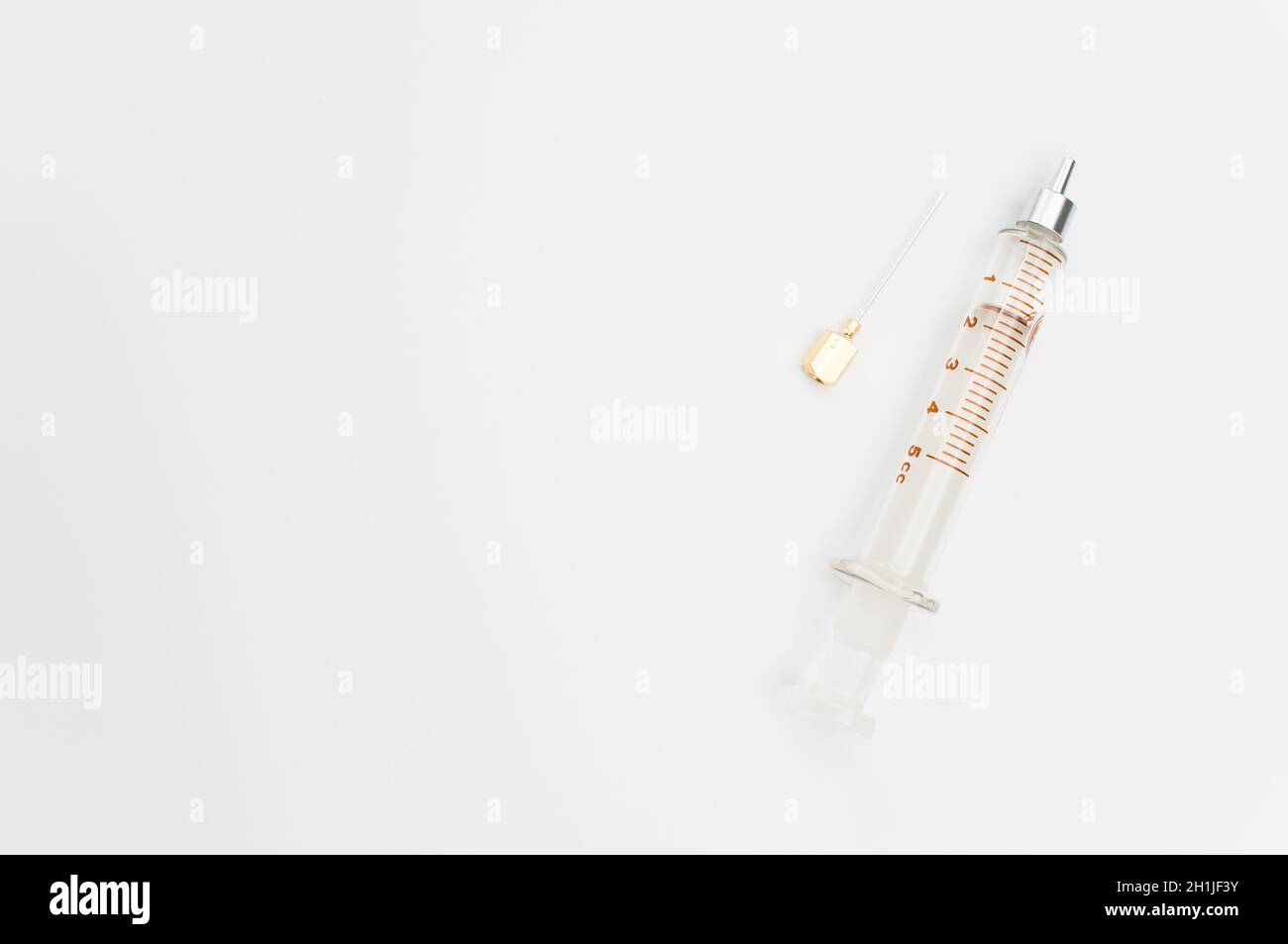 isolated sterilized glass injection syringe on a white surface Stock ...