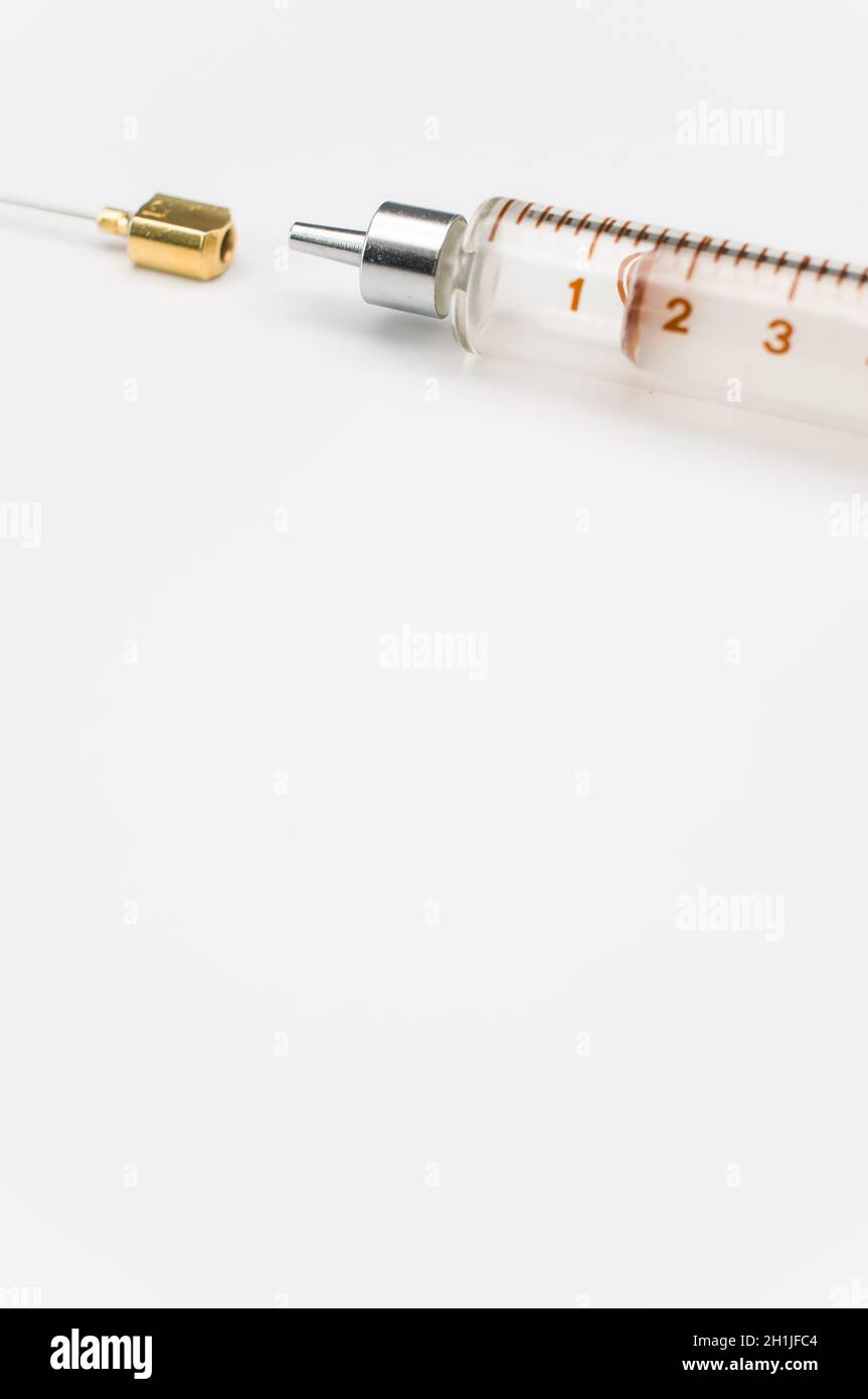 isolated sterilized glass injection syringe on a white surface Stock ...