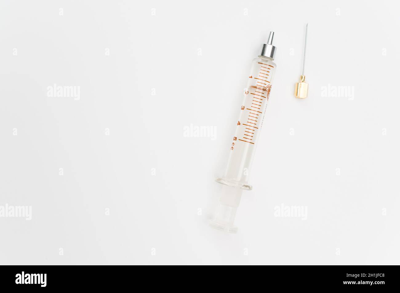 isolated sterilized glass injection syringe on a white surface Stock ...