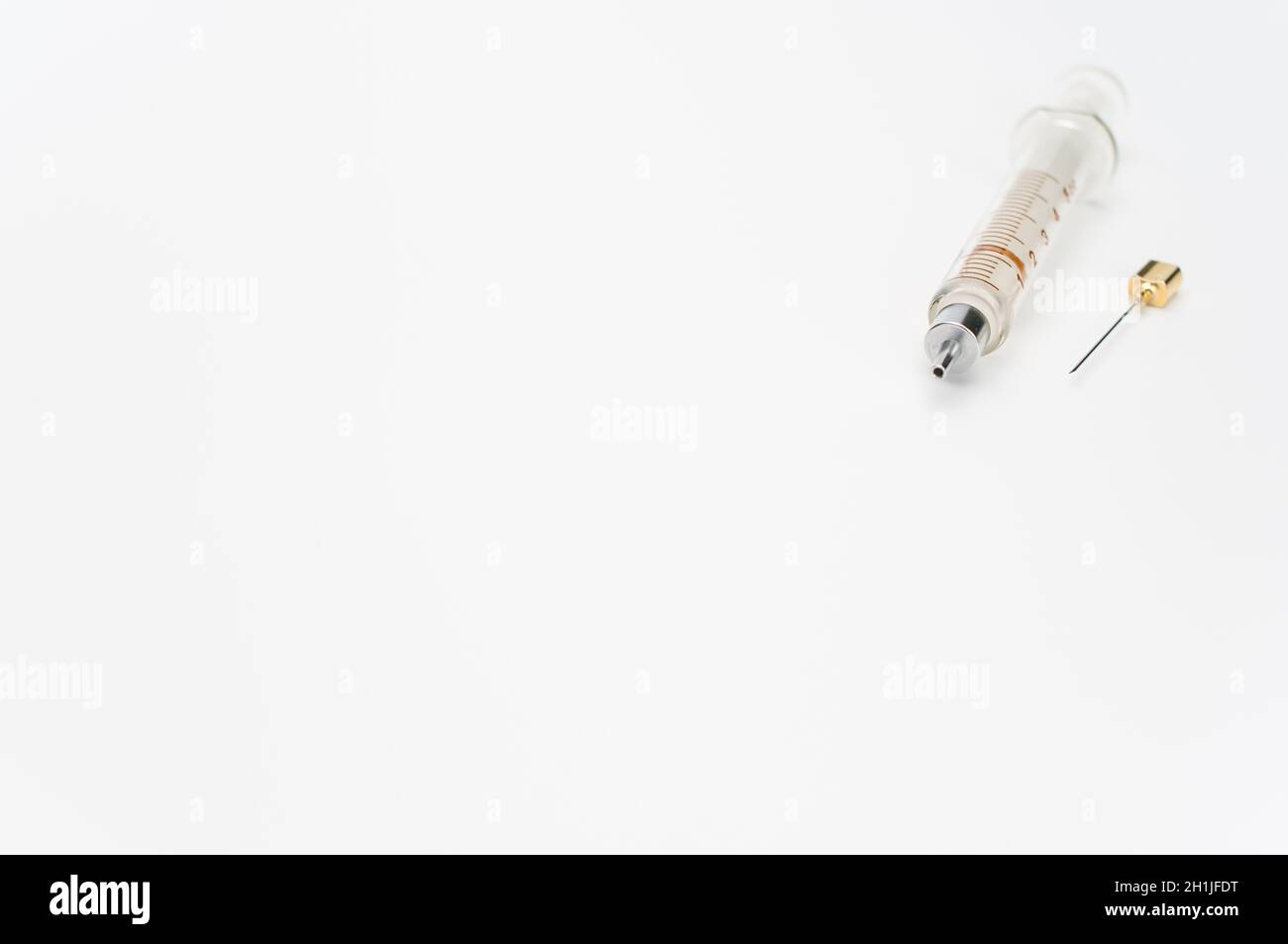 isolated sterilized glass injection syringe on a white surface Stock ...