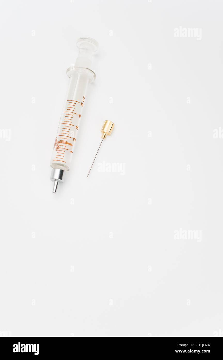 isolated sterilized glass injection syringe on a white surface Stock ...