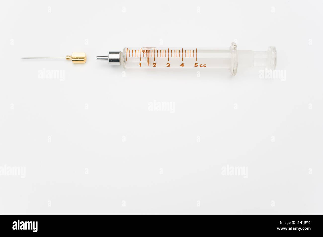 isolated sterilized glass injection syringe on a white surface Stock ...