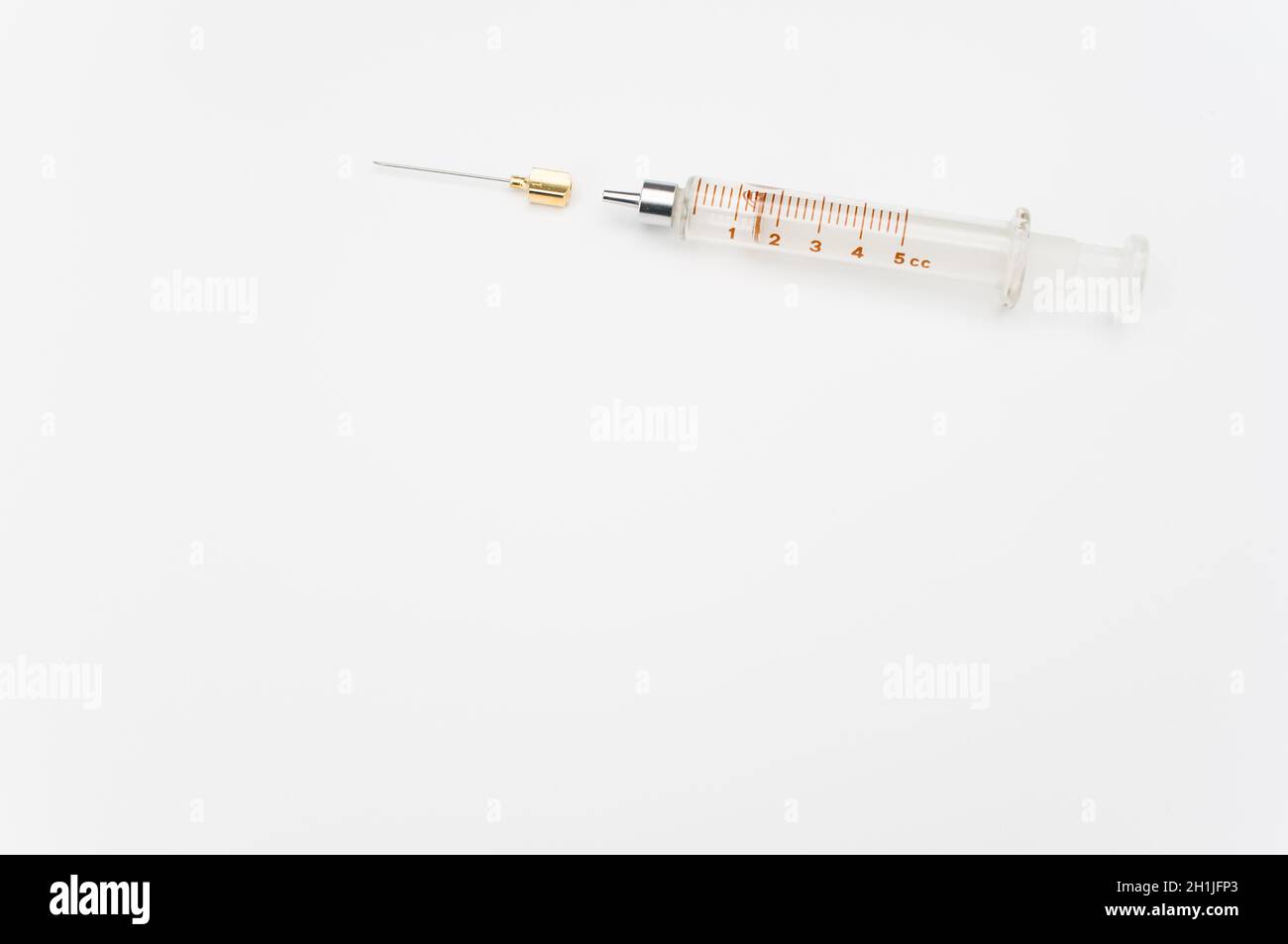 isolated sterilized glass injection syringe on a white surface Stock ...