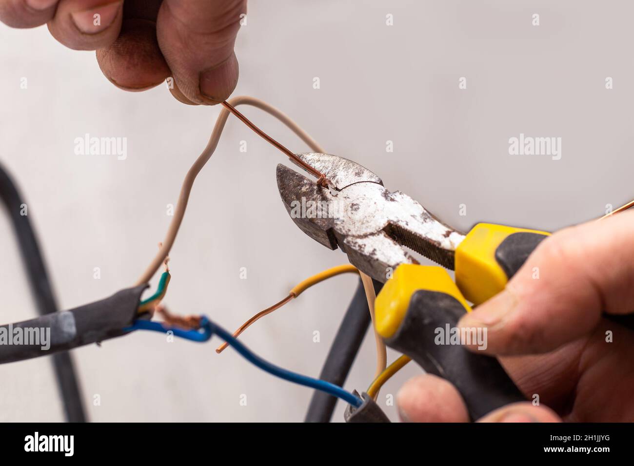 The electrician cuts the wires with pliers. Installation of electrical ...