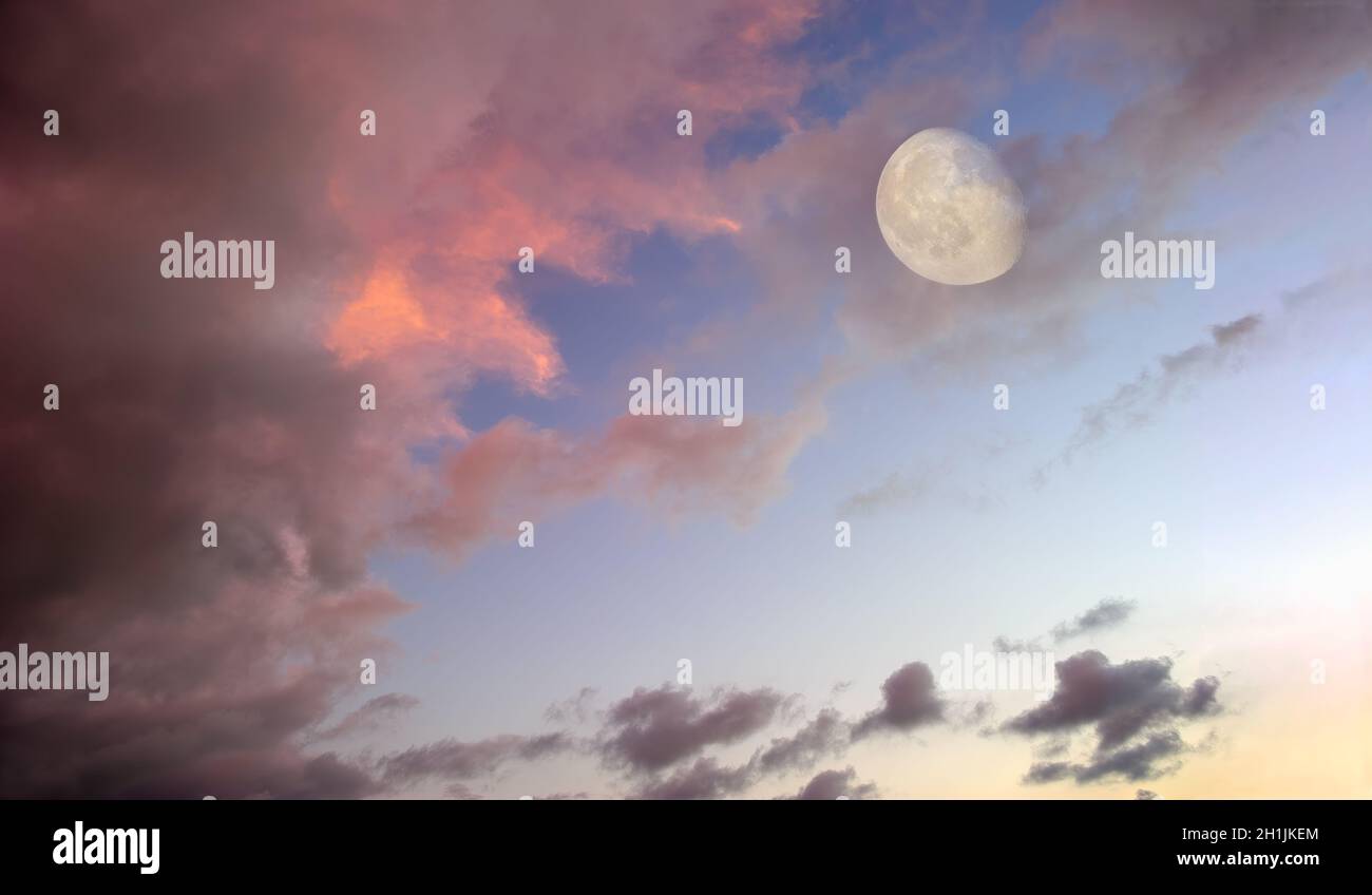 The Moon Is Rising In The Sky With Soft Clouds Set Against A Bright ...