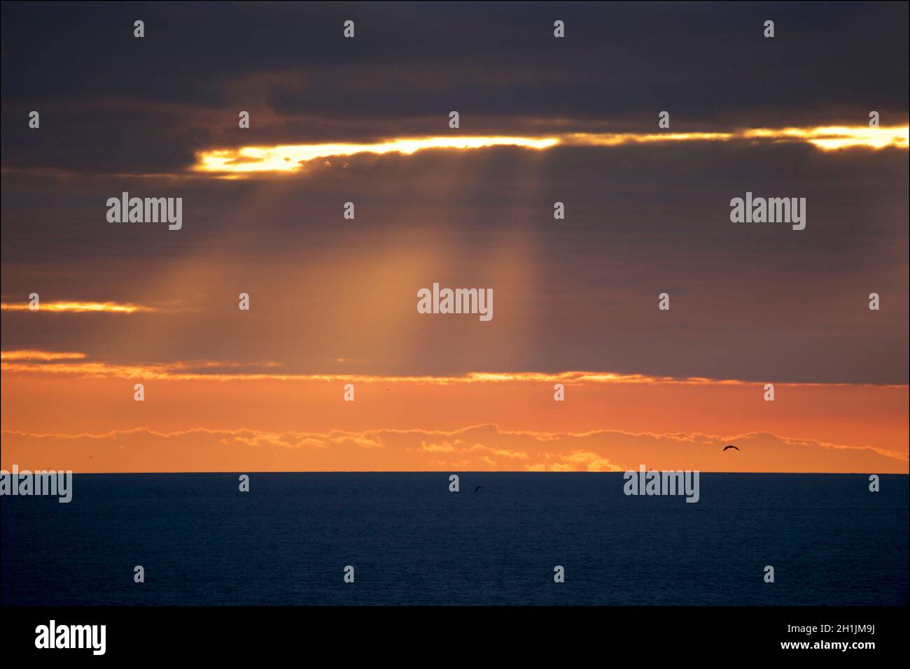 The English Channel. Moody clouds and sun rays at sunset. The horizon ...
