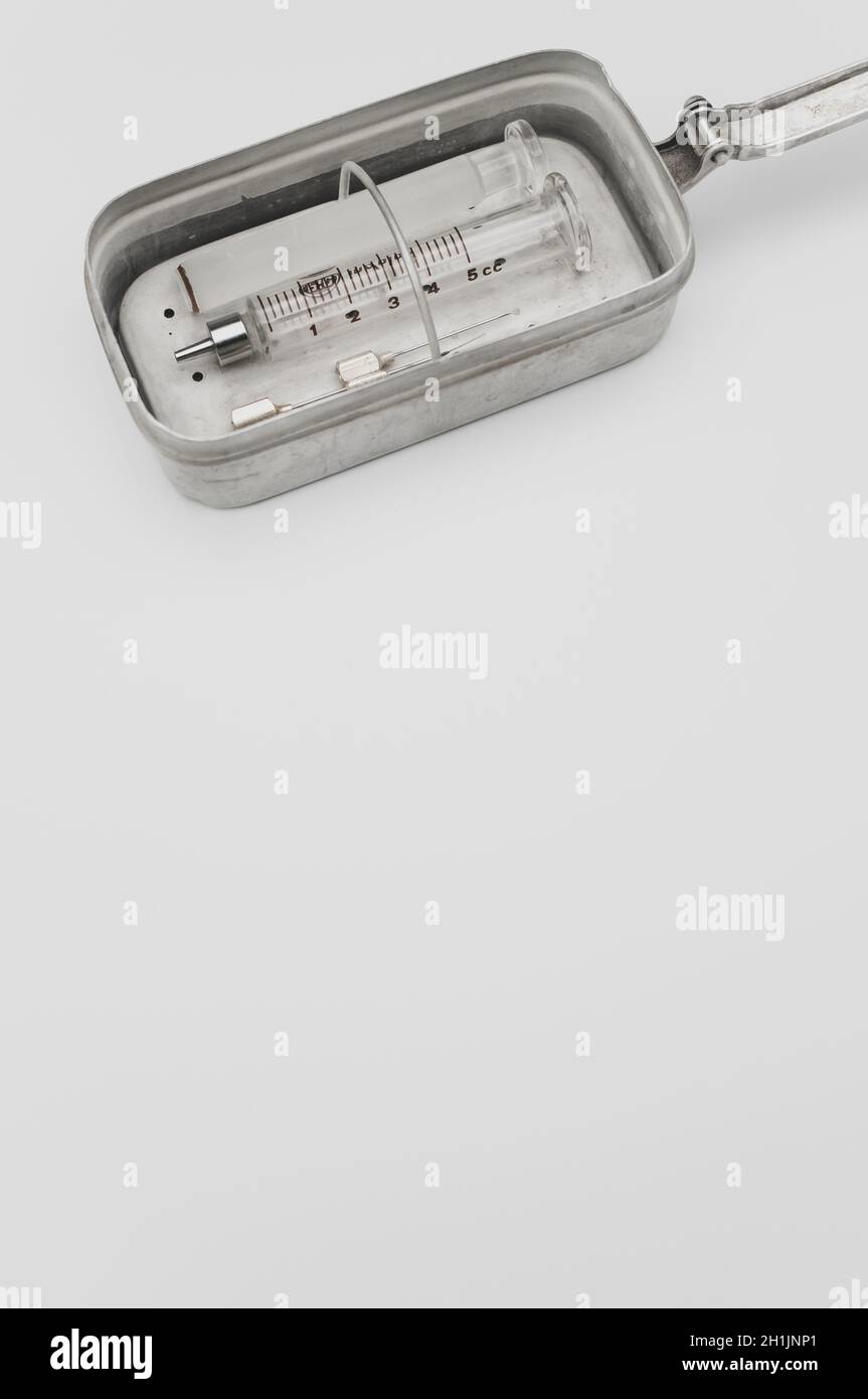 isolated sterilized glass injection syringe in a box on a white ...