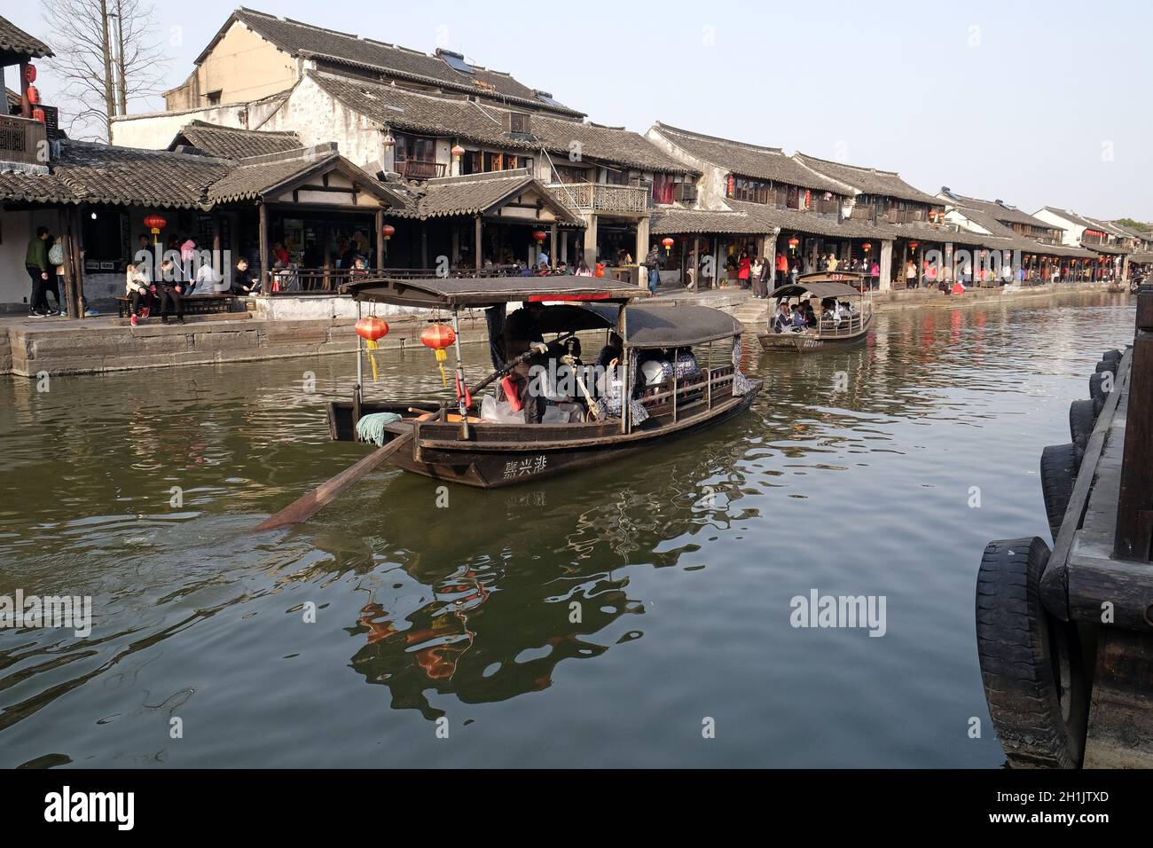 Tourist boats on the water canals of Xitang Town in Zhejiang Province ...