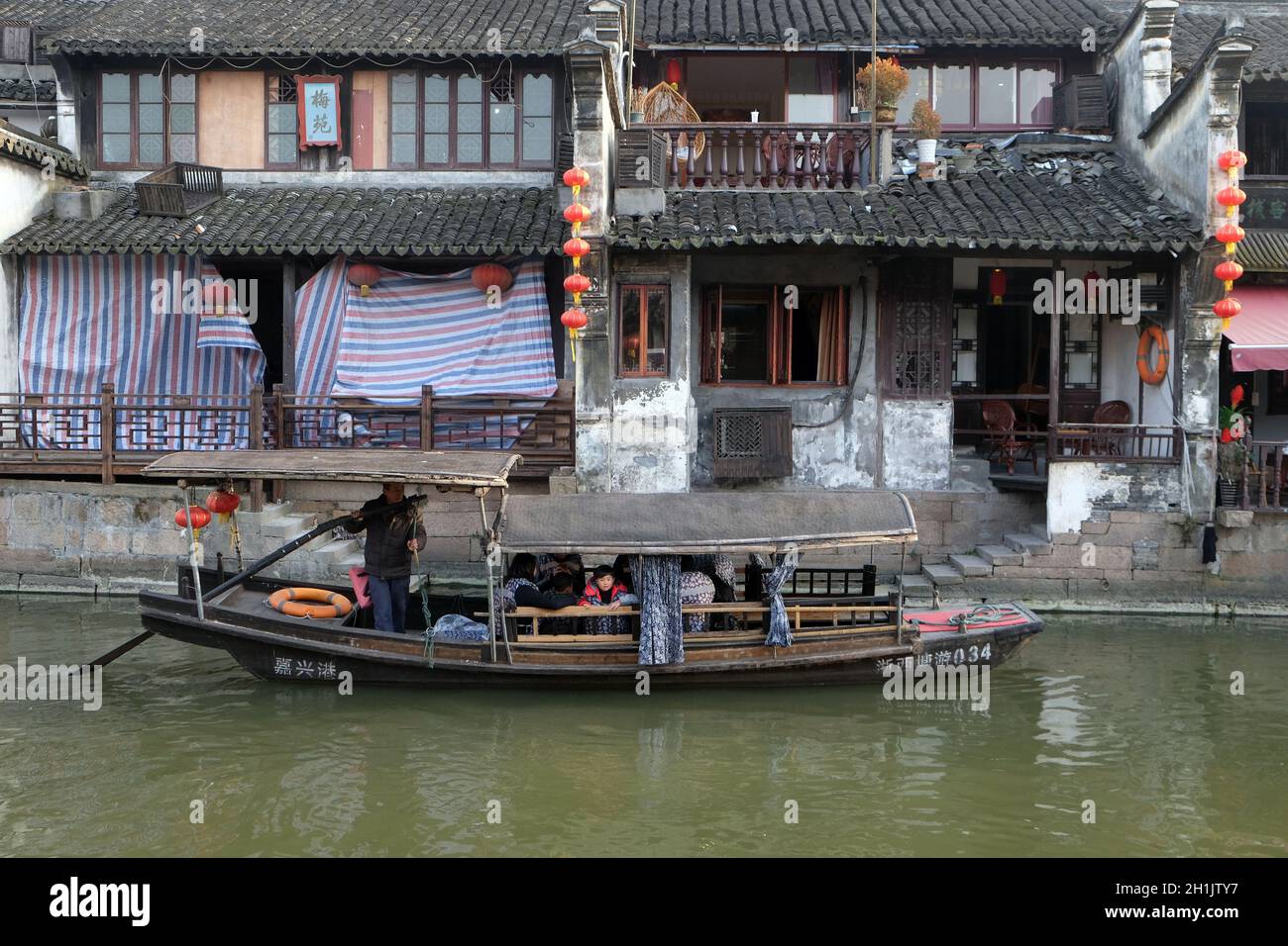 Tourist boats on the water canals of Xitang Town in Zhejiang Province ...