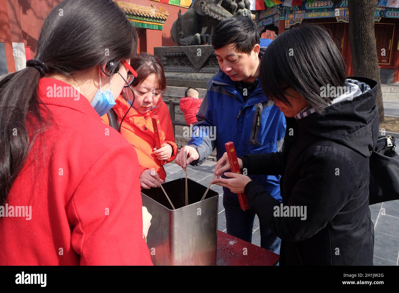 Worshippers holding incense sticks pray at Yonghegong Lama Temple in ...