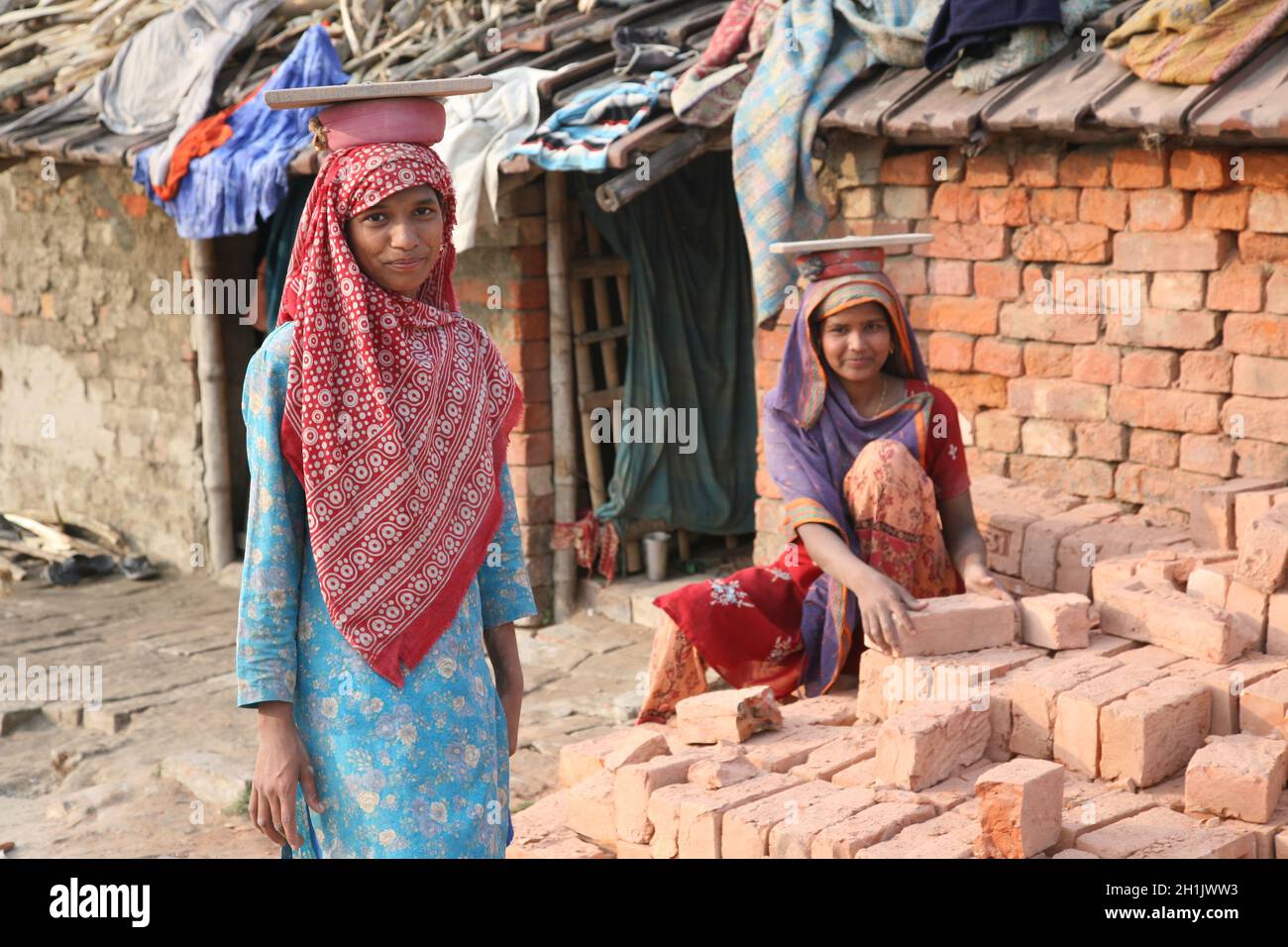 Brick field workers carrying complete finish brick from the kiln in ...