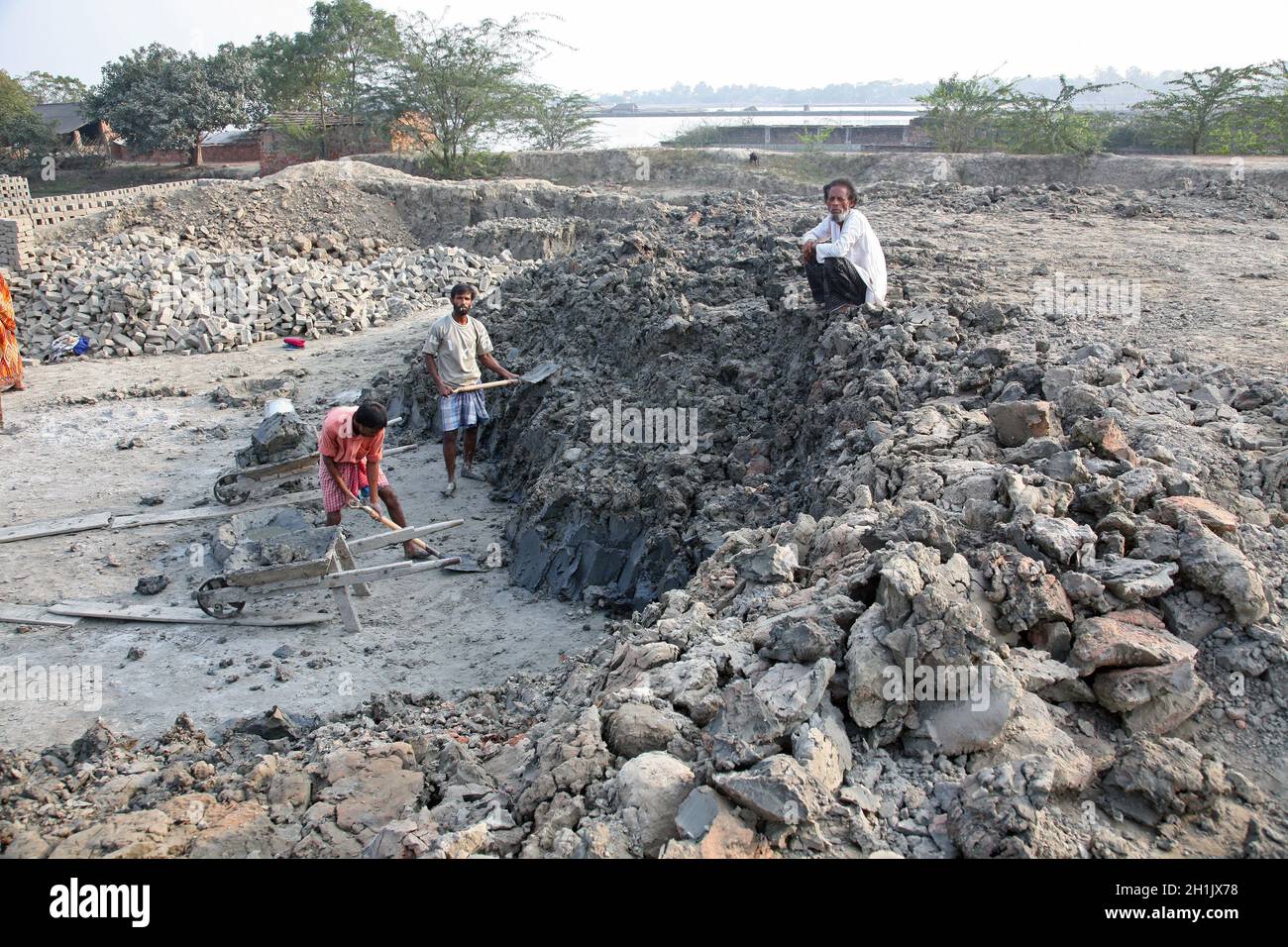 Brick field. Laborers are carrying deposited soil for making raw brick ...